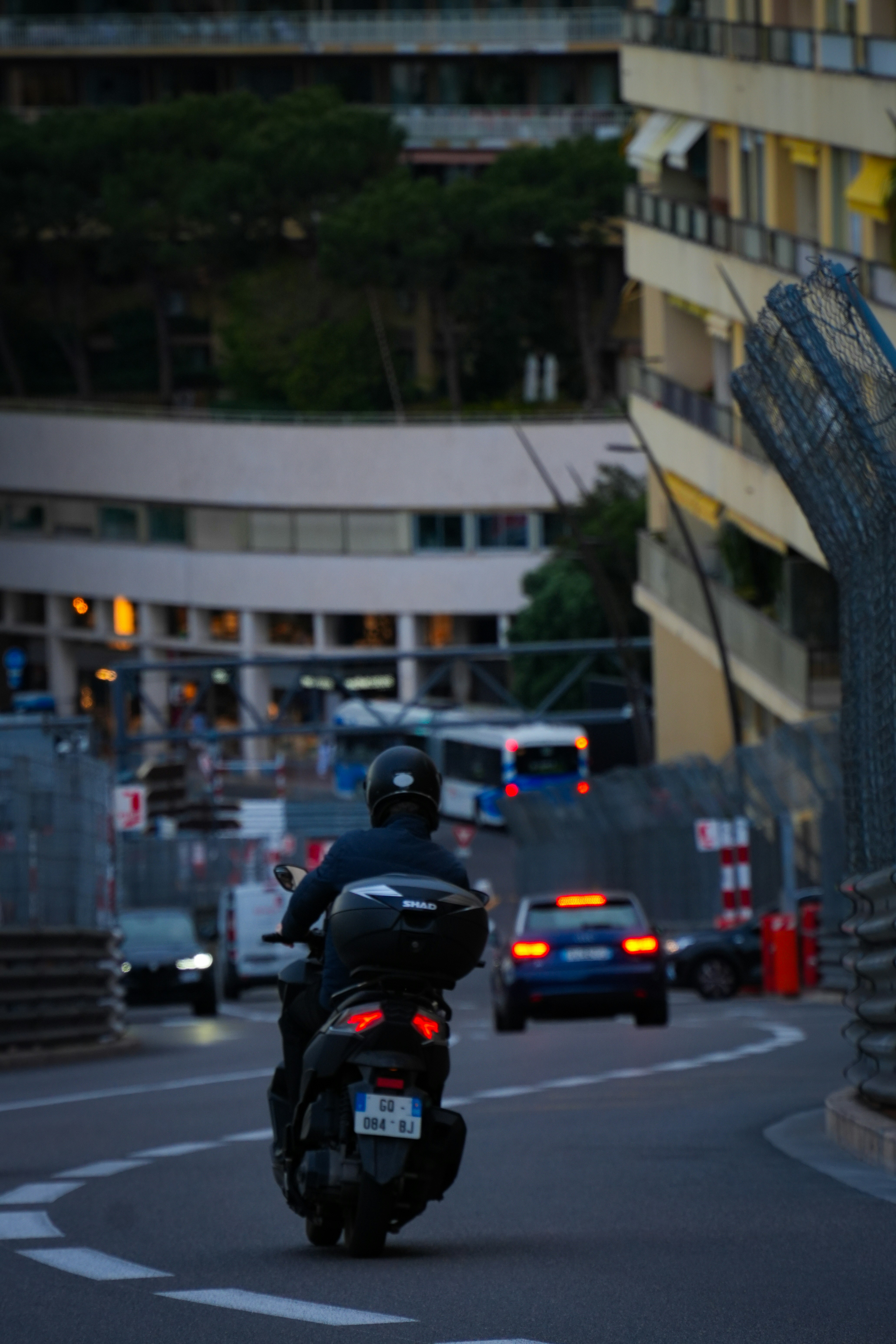 Midtown Pursuit: Rider Cresting a Neon-Glow Street at Dusk