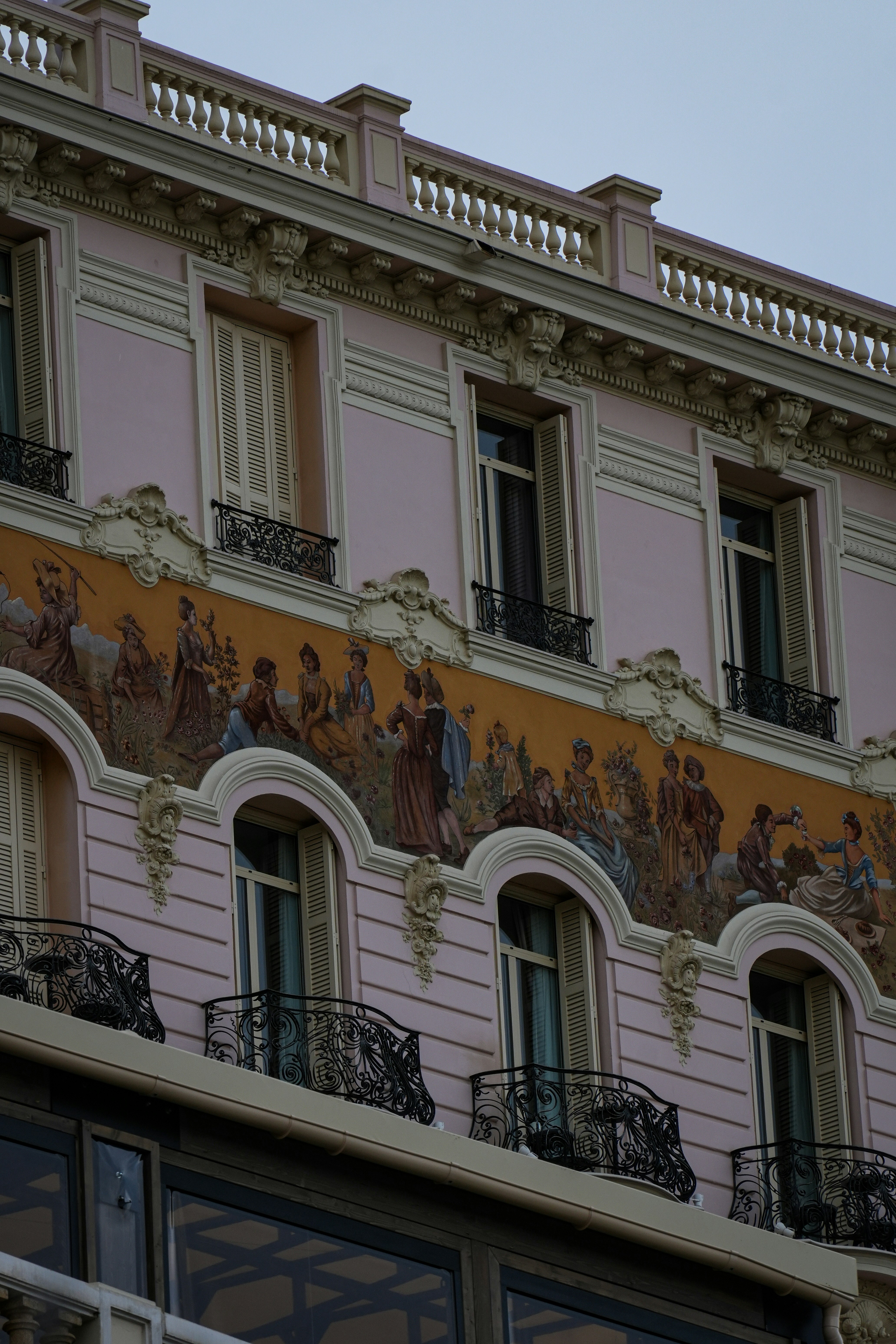 Pastel Facade and Frescoed Arcades of a Belle Époque Building
