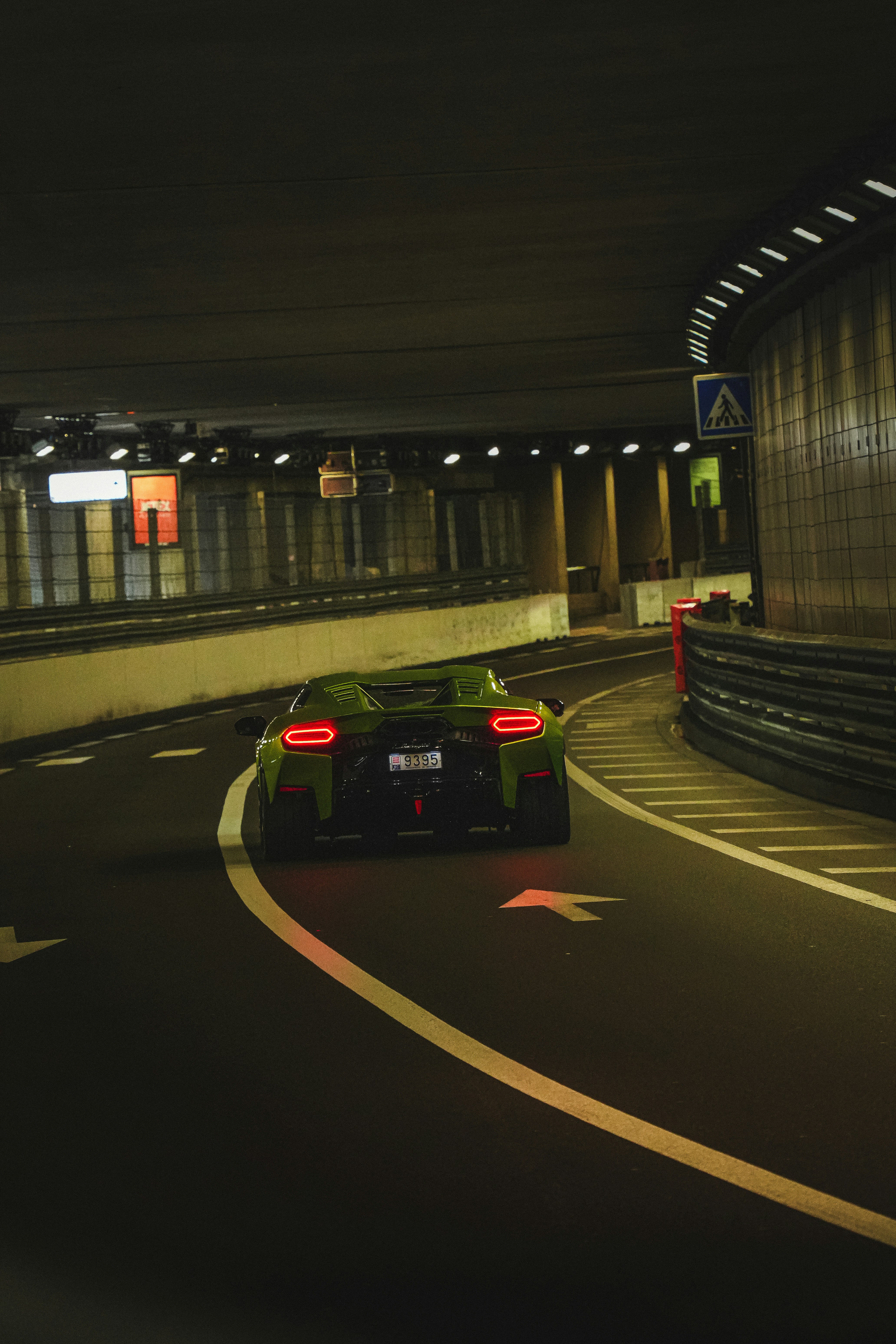 Green Supercar Rounds a Neon-illuminated Tunnel