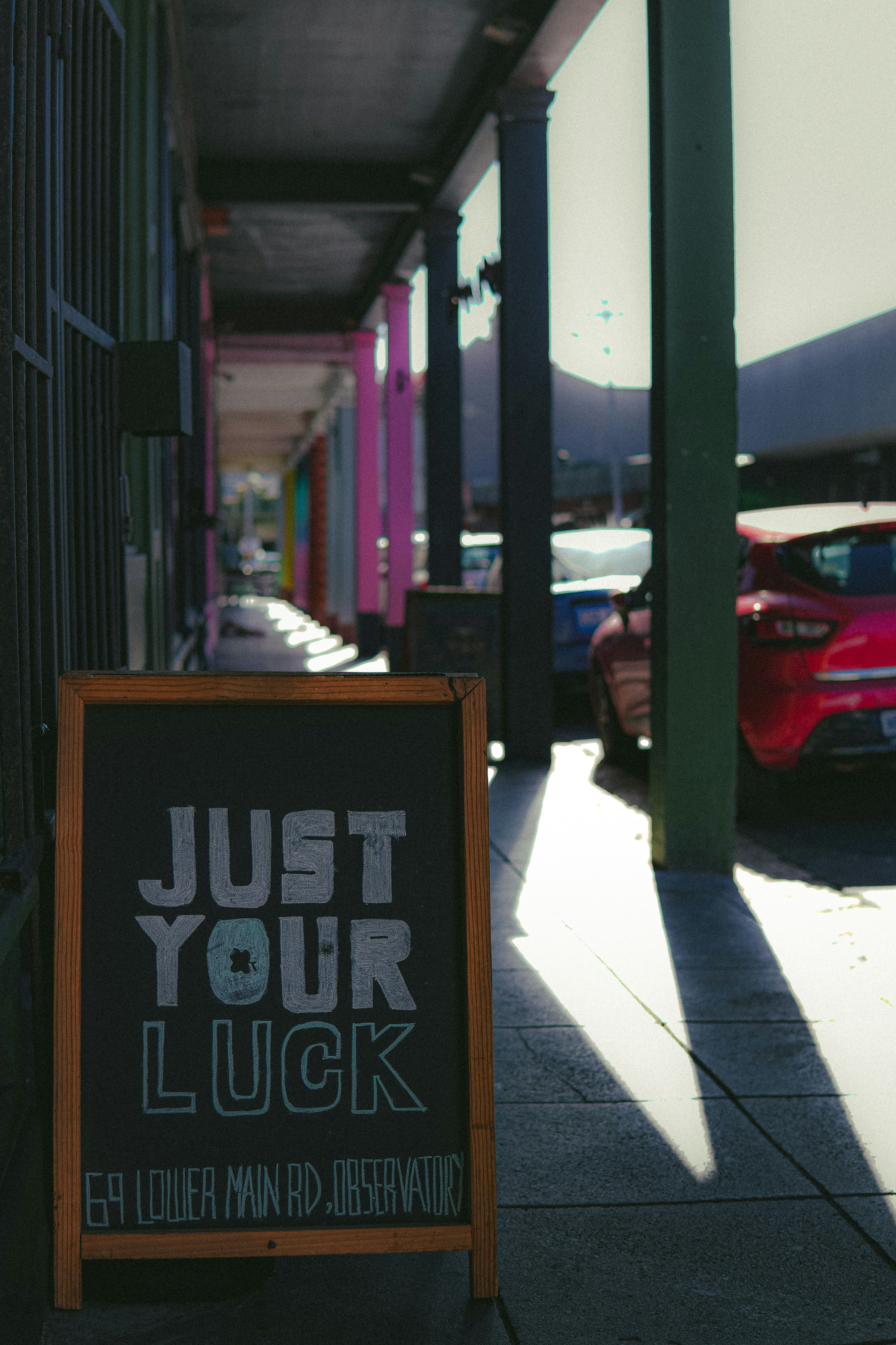 Chalkboard of Chance: Just Your Luck on a Sunlit Street