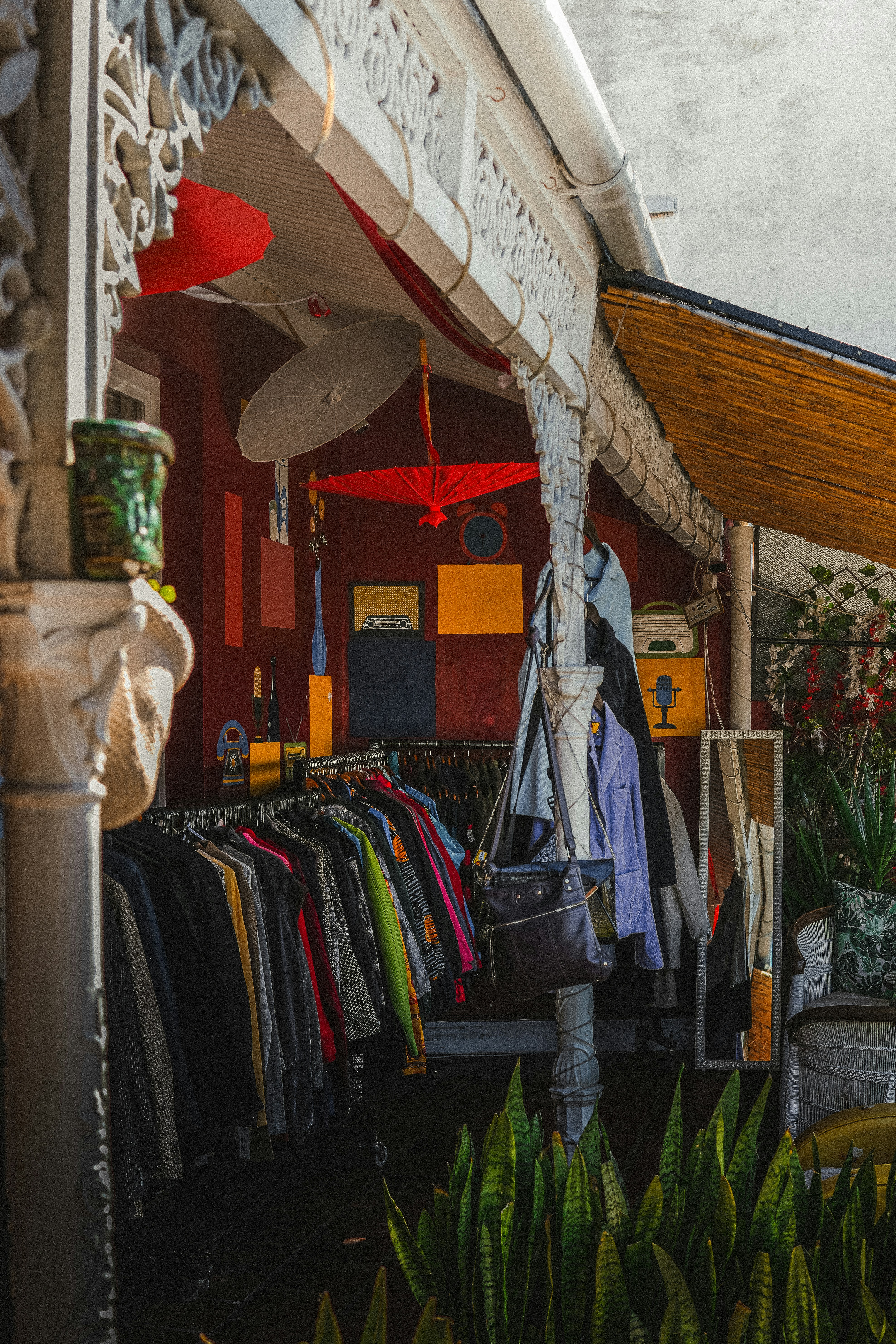 Boutique Alley: Colorful Cloths Under a Shadowed Canopy
