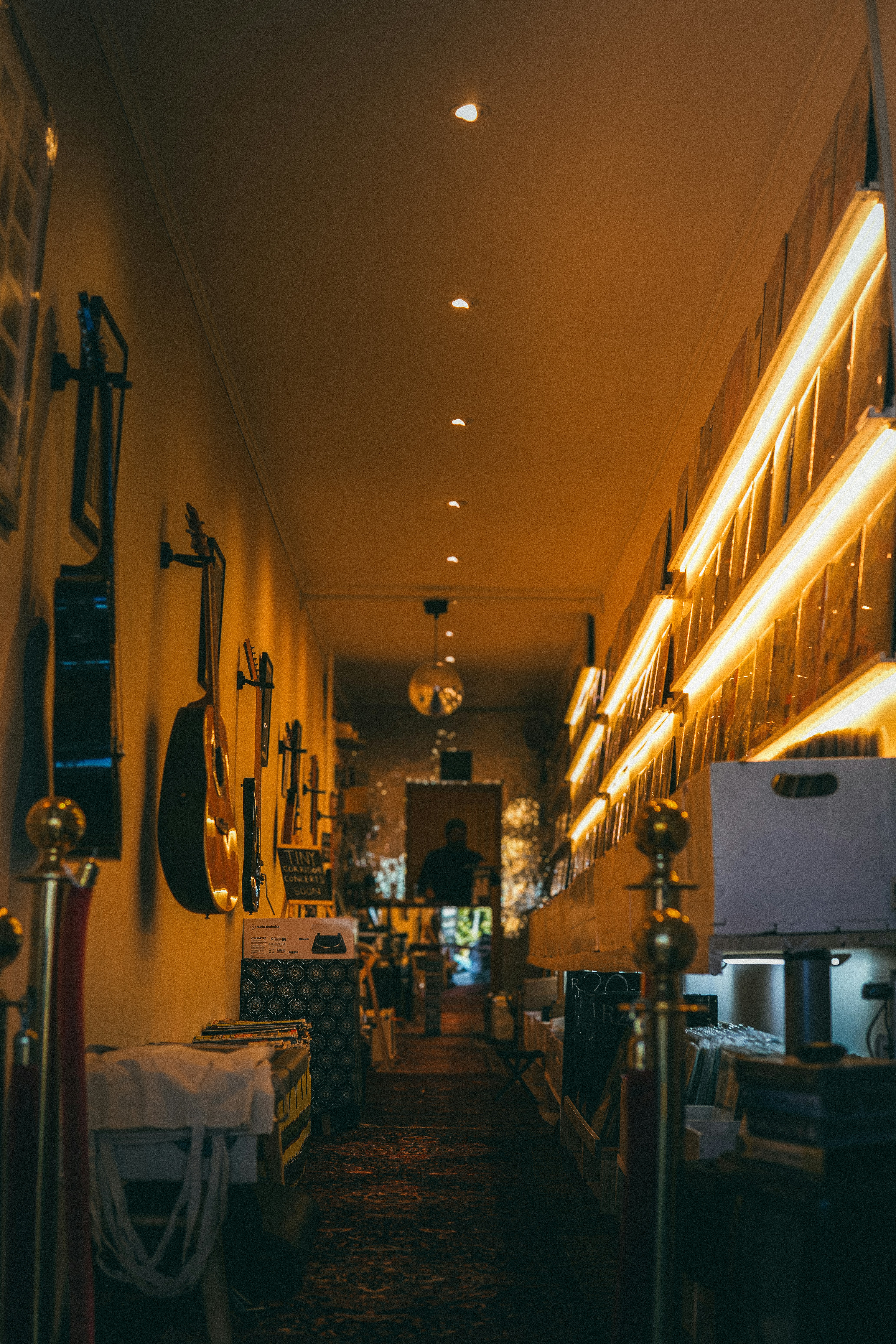 Neon Corridor: A Guitar Shop's Golden Hour Glow