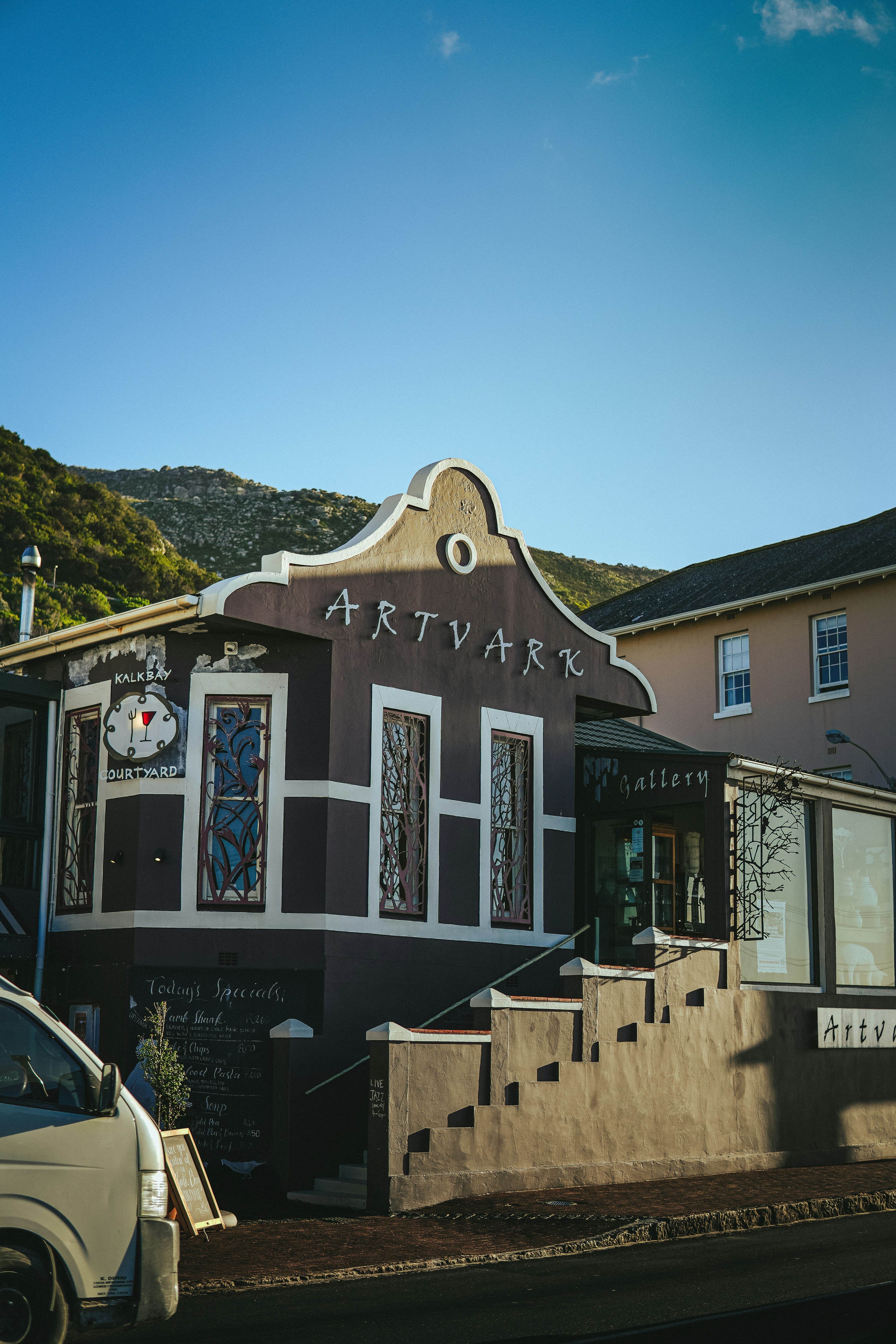 Artful storefront with ornate façade under a clear blue sky