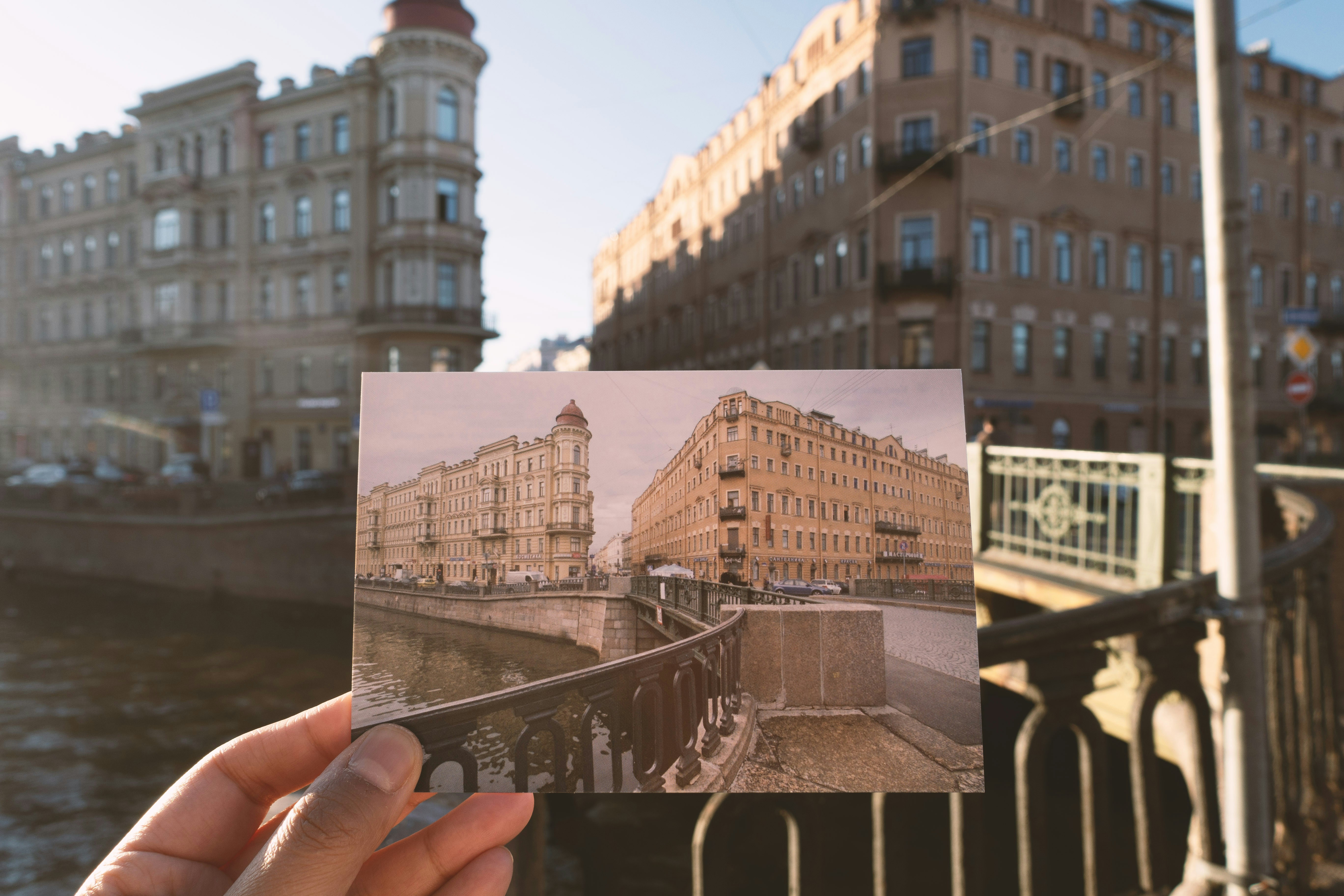 A Handheld Viewfinder: Cityscape Through a Printed Postcard