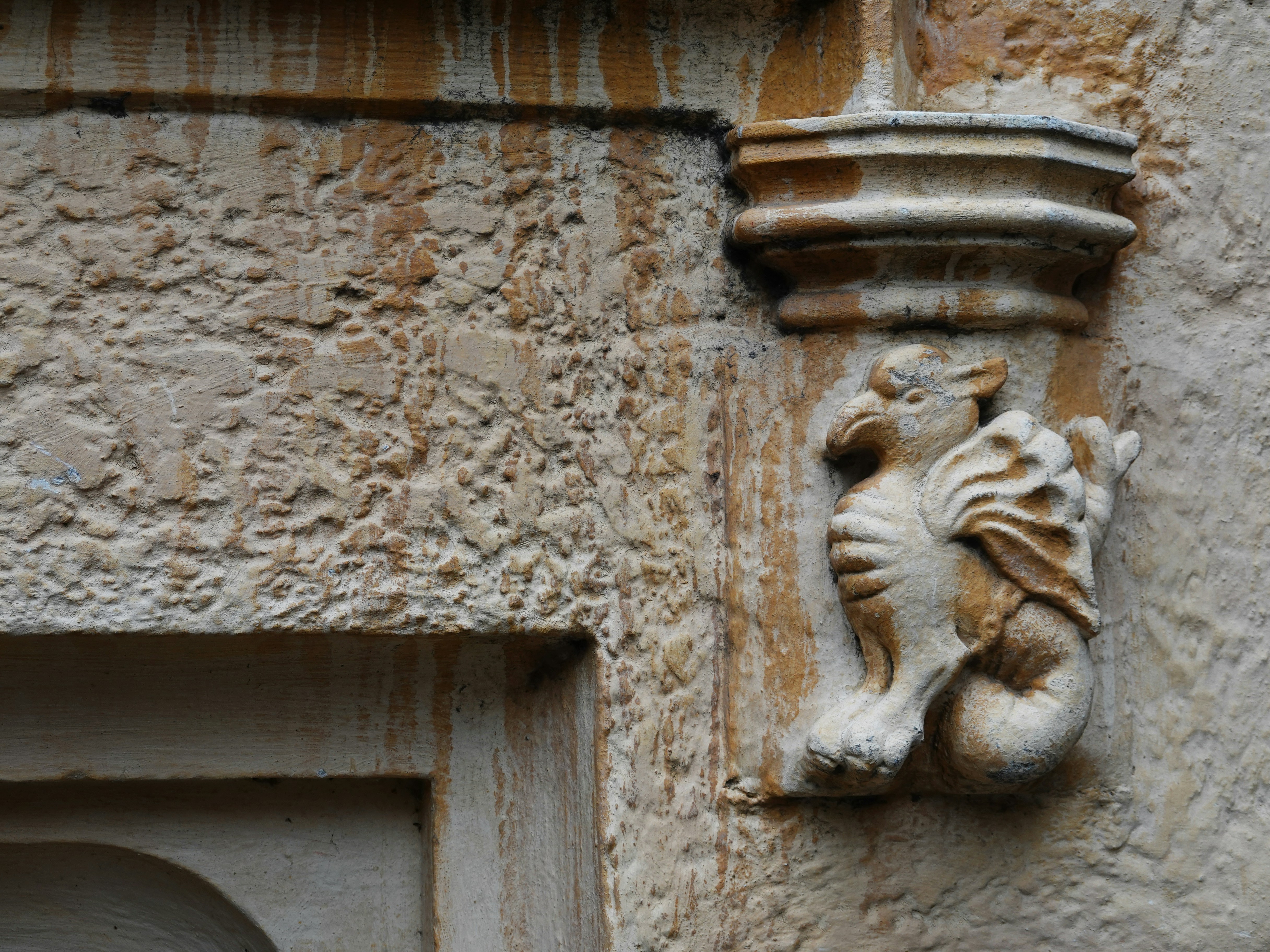 Stone Griffin Niche: Weathered Carving Holding Time on a Tuscan Wall