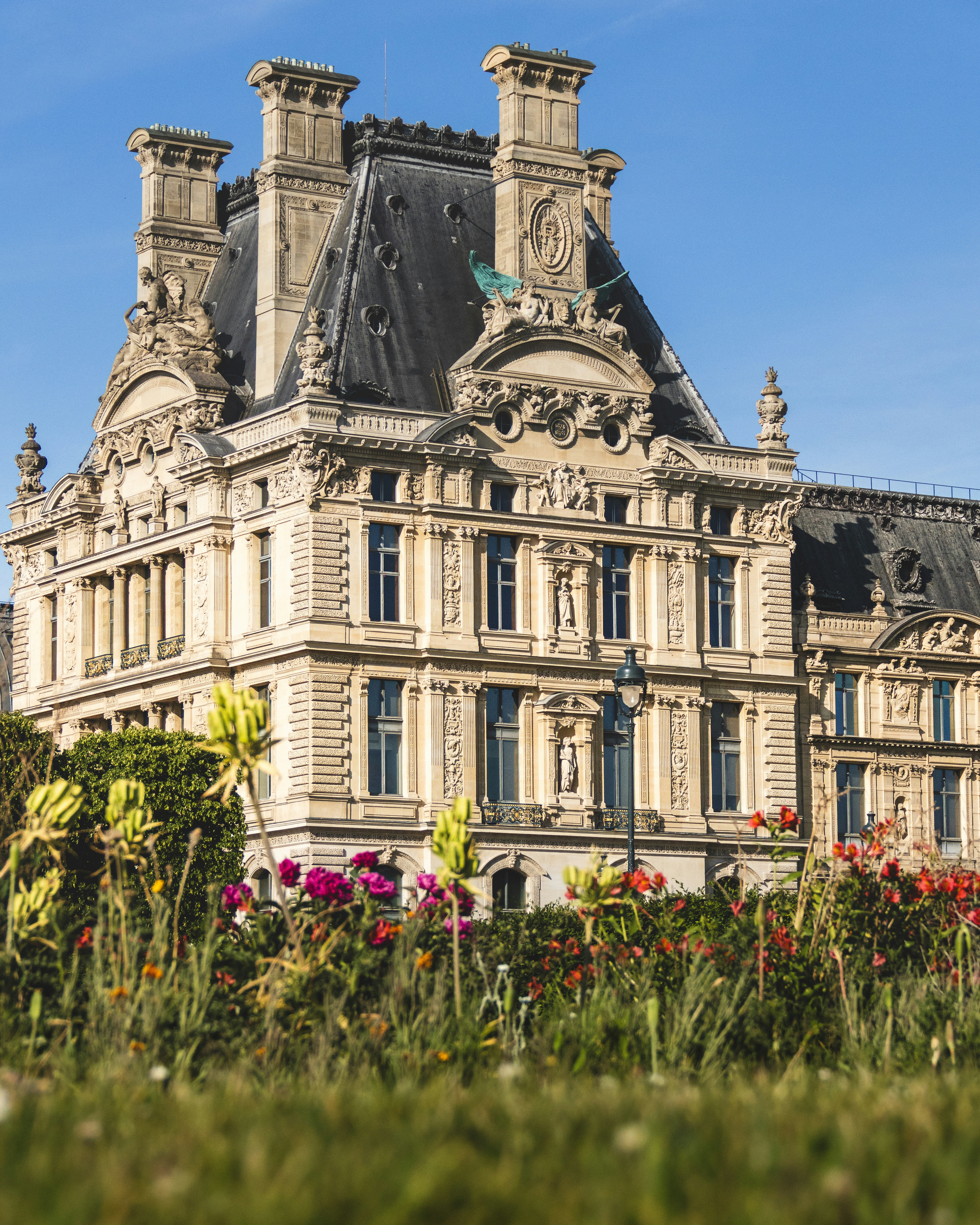 Ornate Parisian Facade Rising Above a Blooming Forecourt