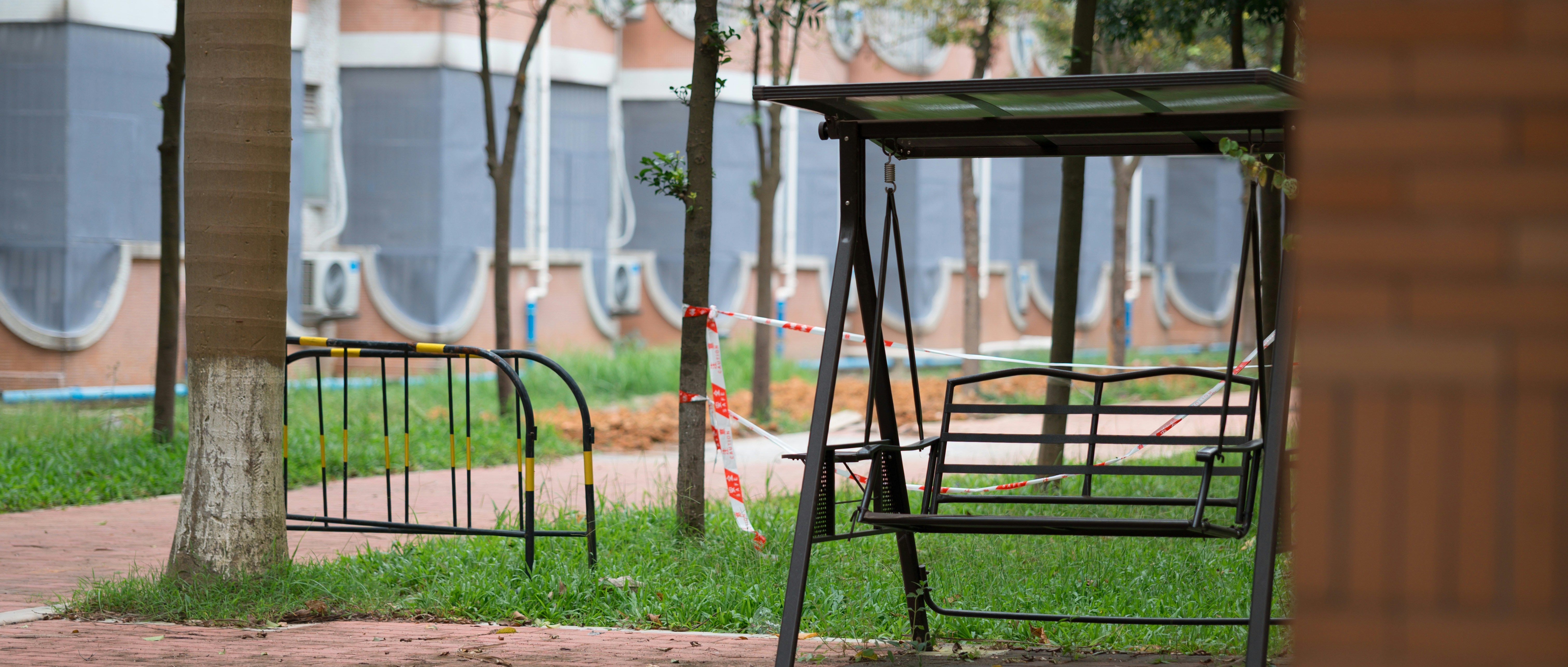 Quiet Playground Swing Under Shaded Shelter