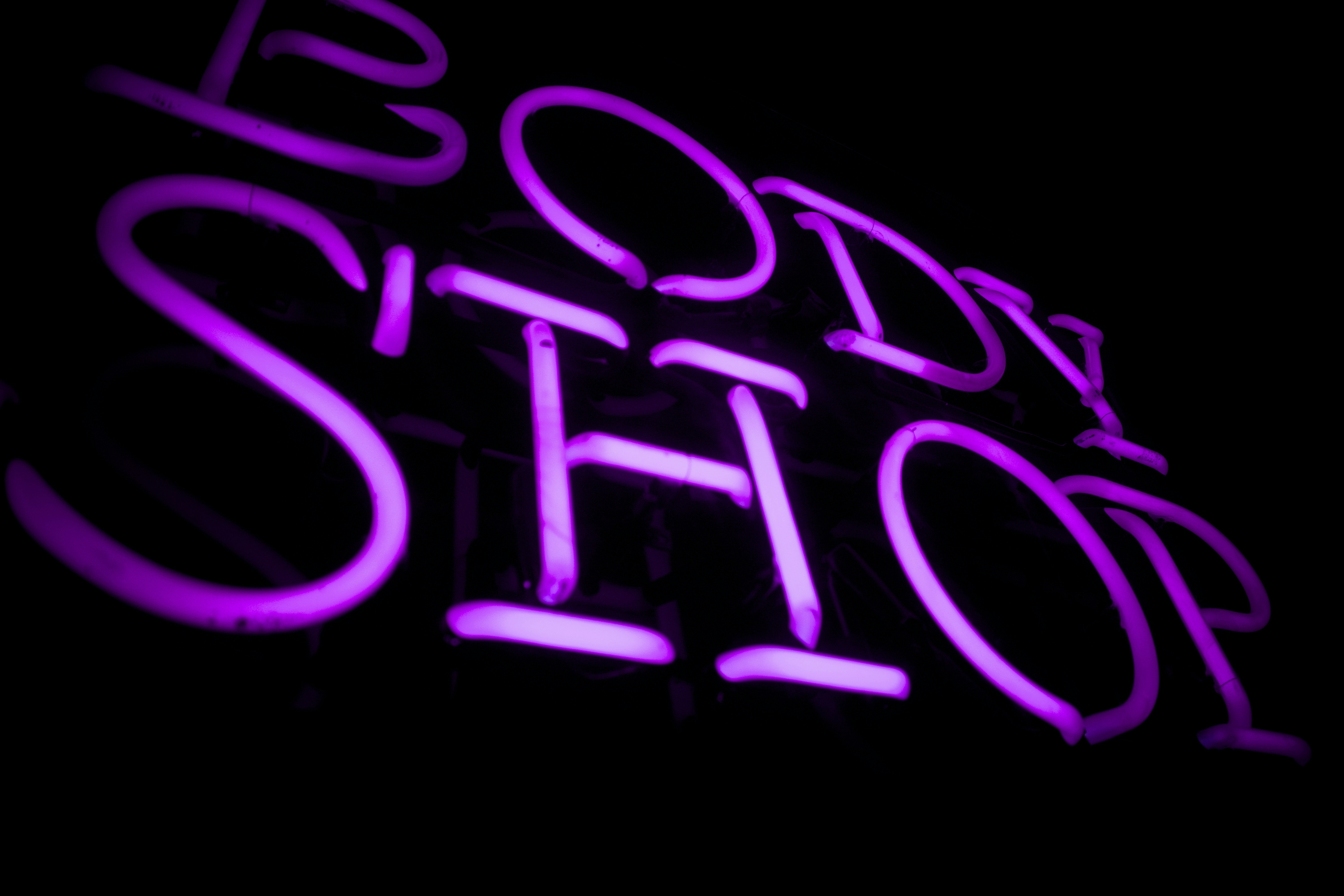 Neon Night School: A Violet Sign Glows in Darkness