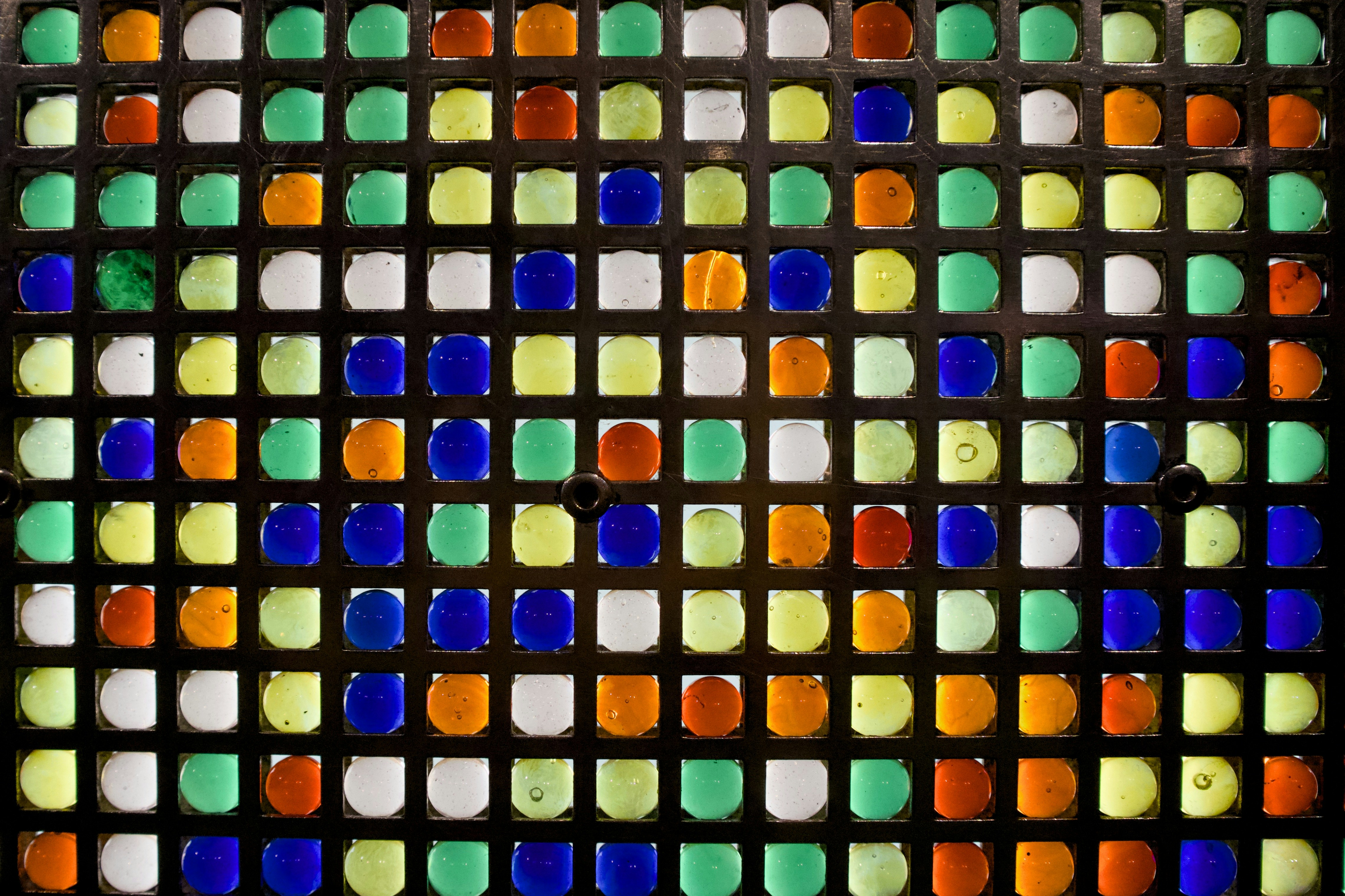 Vivid Grid: Multicolored Orbs Behind Glass