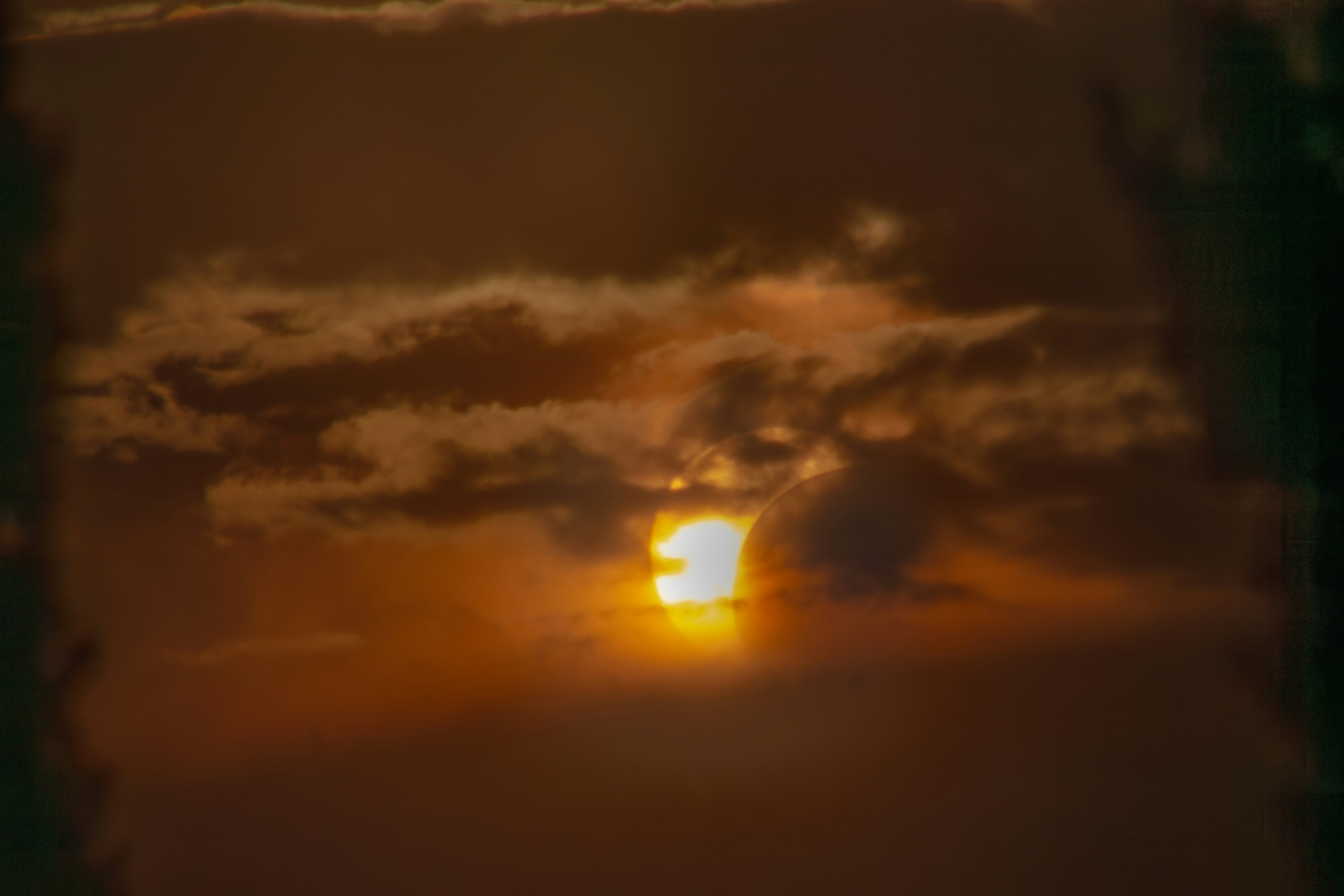 Muted Sunset Through Cloud Veil