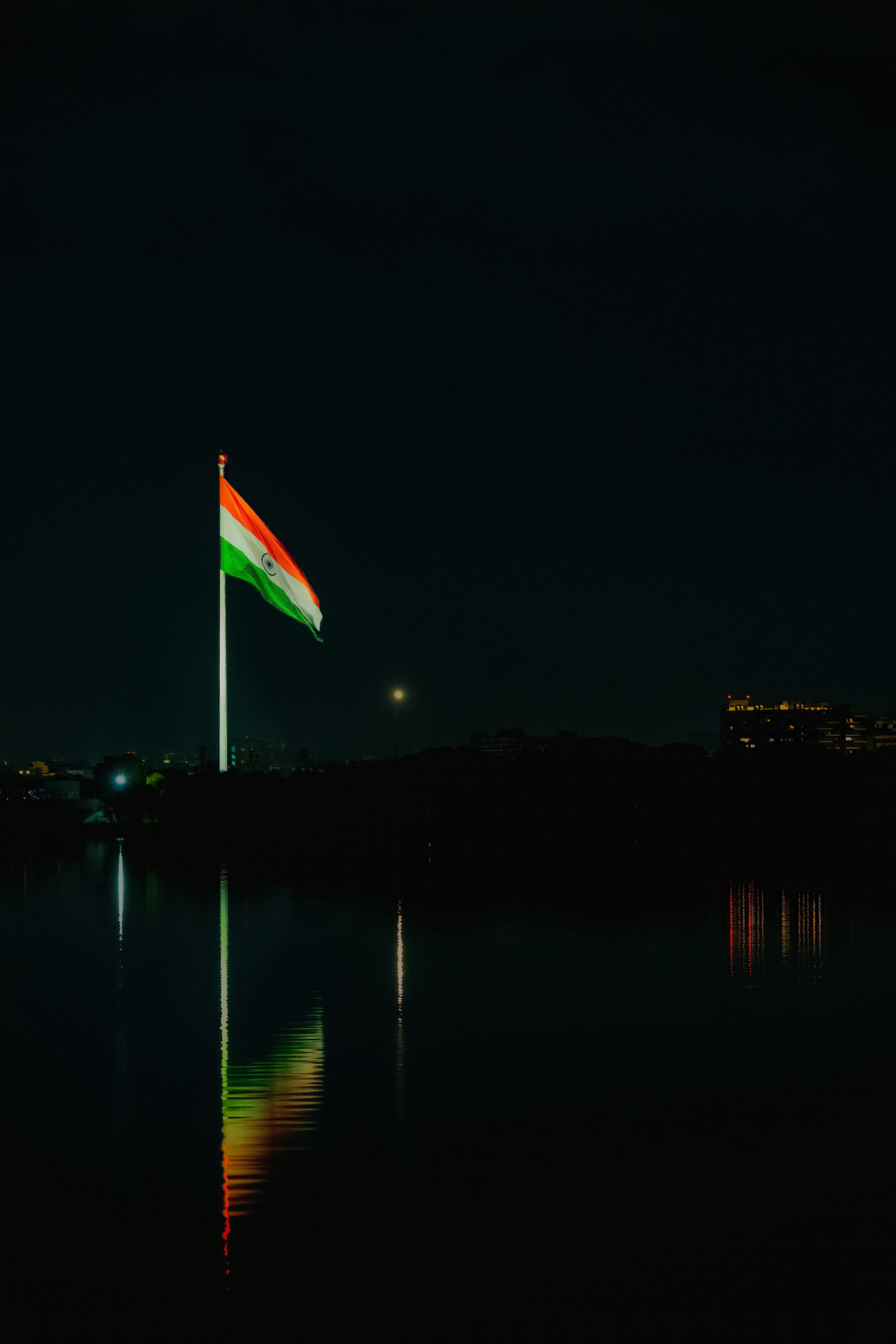 Flag of India Over Quiet Waters at Night