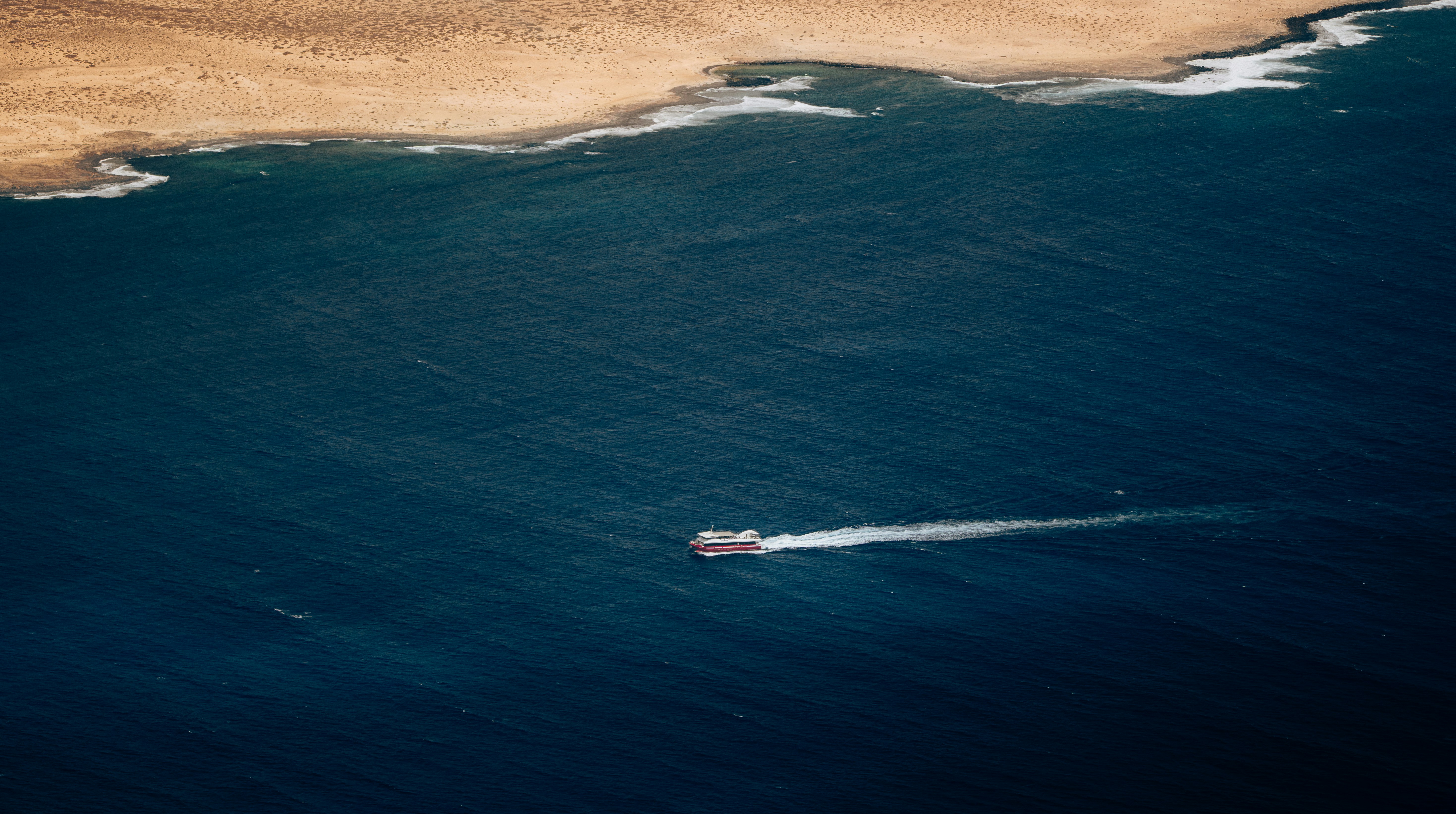 Coastal Vessel Slicing Through Deep Blue Frontier