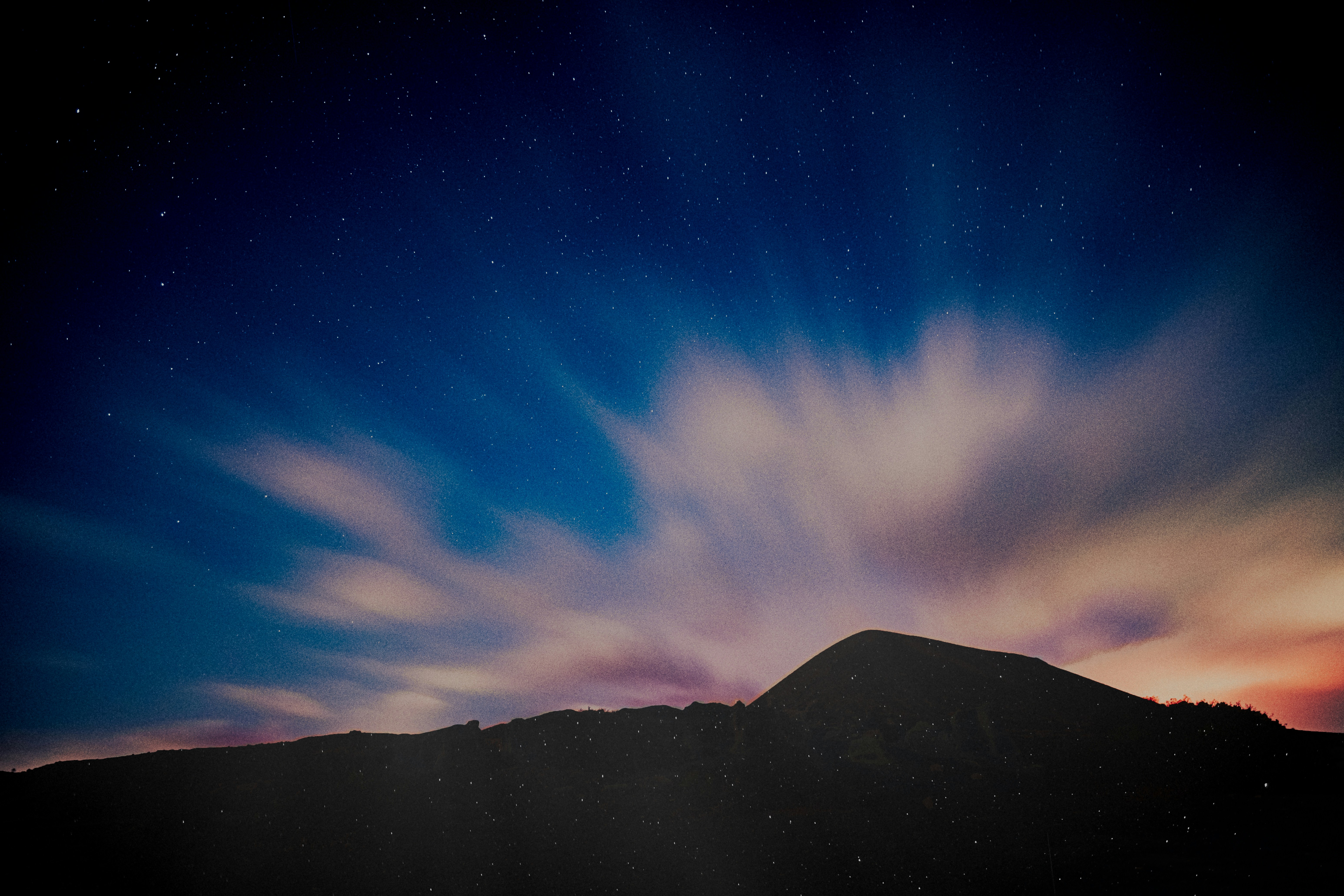 Starlit Silhouette over a Distant Ridge