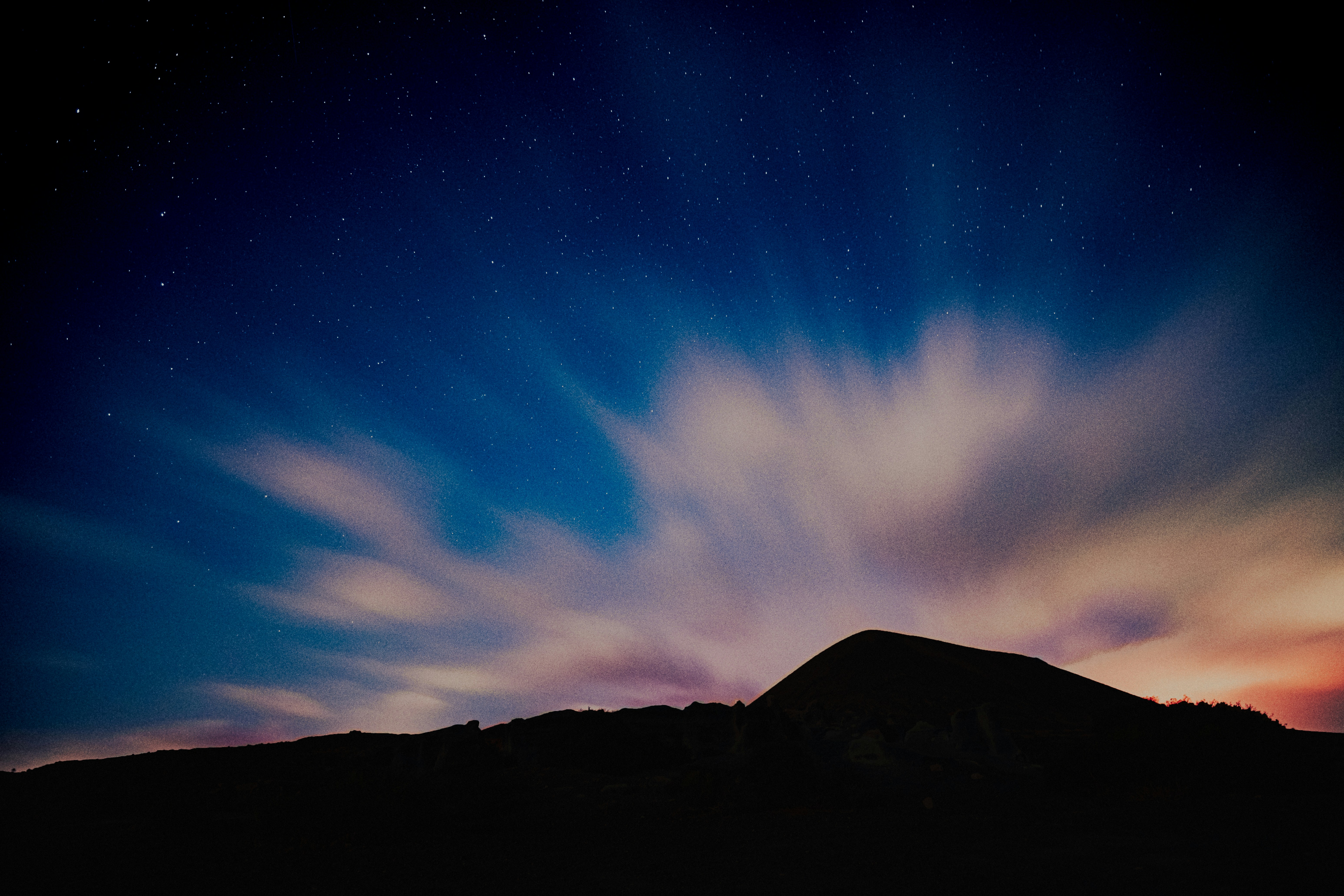 Night Sky Over Silent Ridge: A Gradient of Stars and Clouds