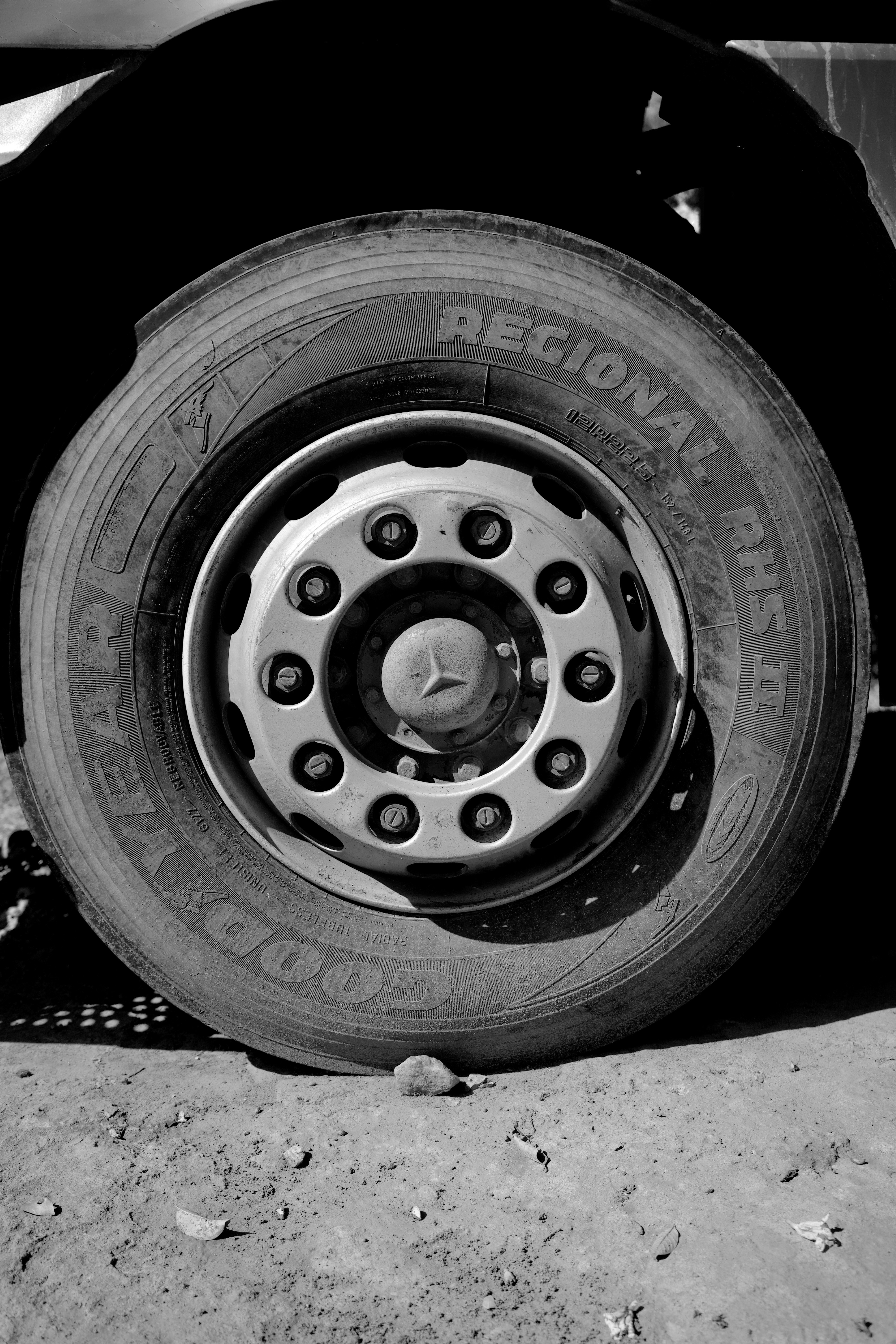Wheel Circle: A Black-and-White Close-Up of a Truck Tire Hub