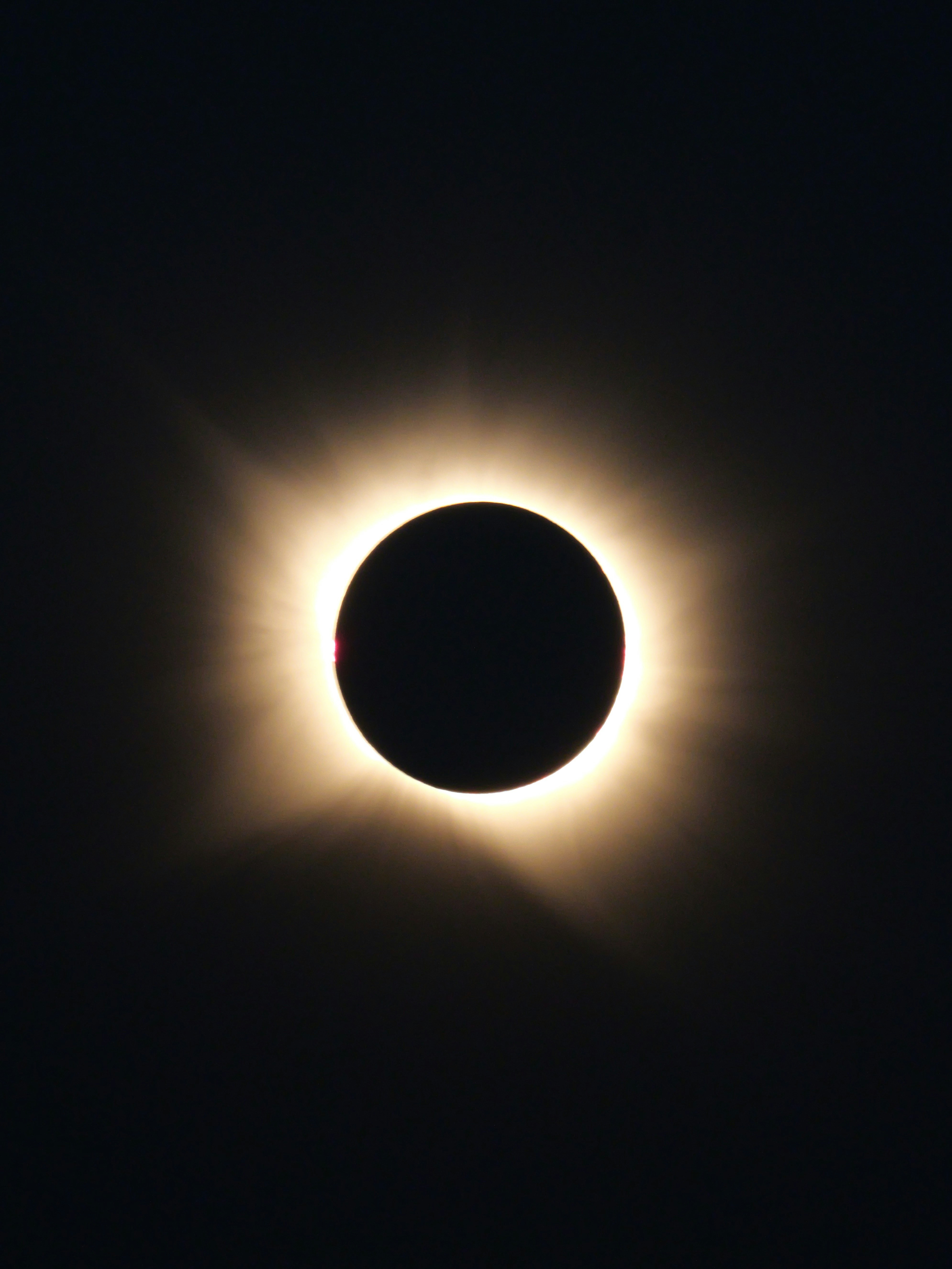 A total solar eclipse with a bright corona against a dark sky.