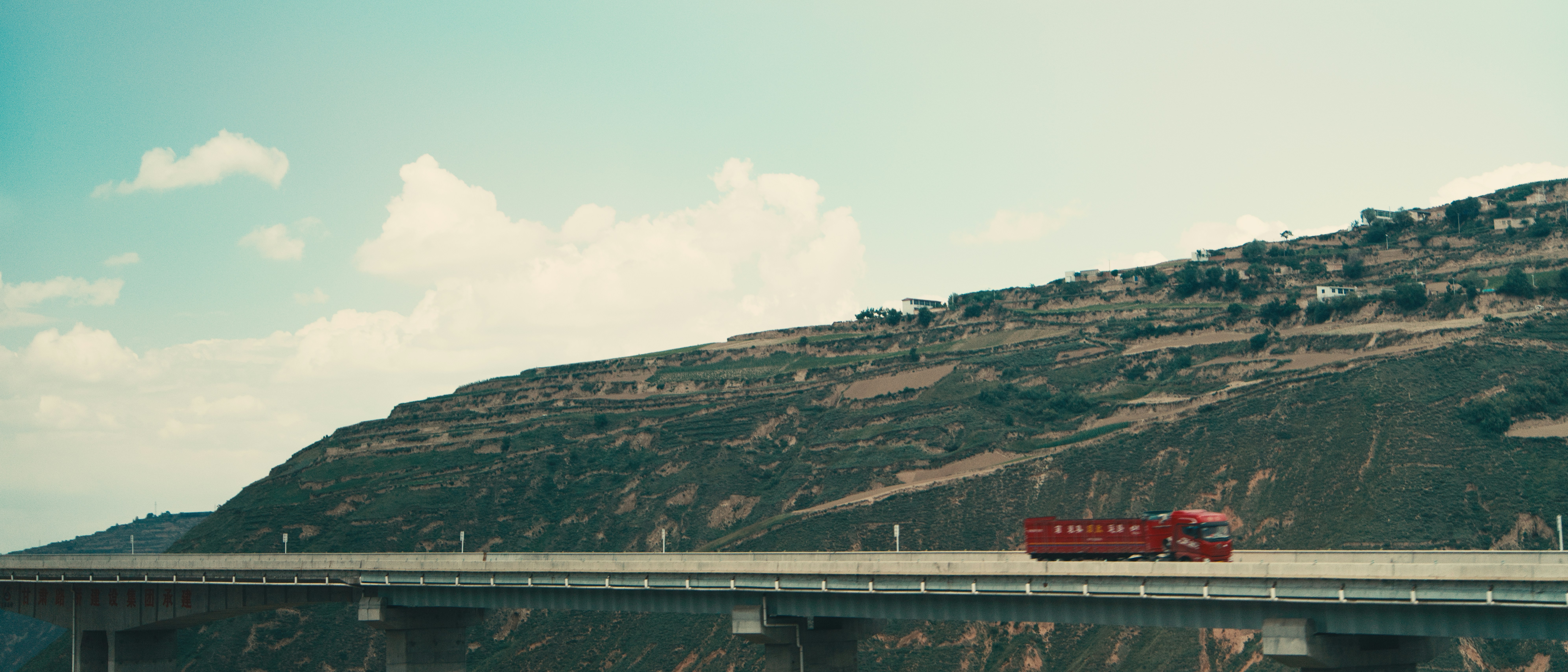 Red Truck on a Quiet Mountain Bridge