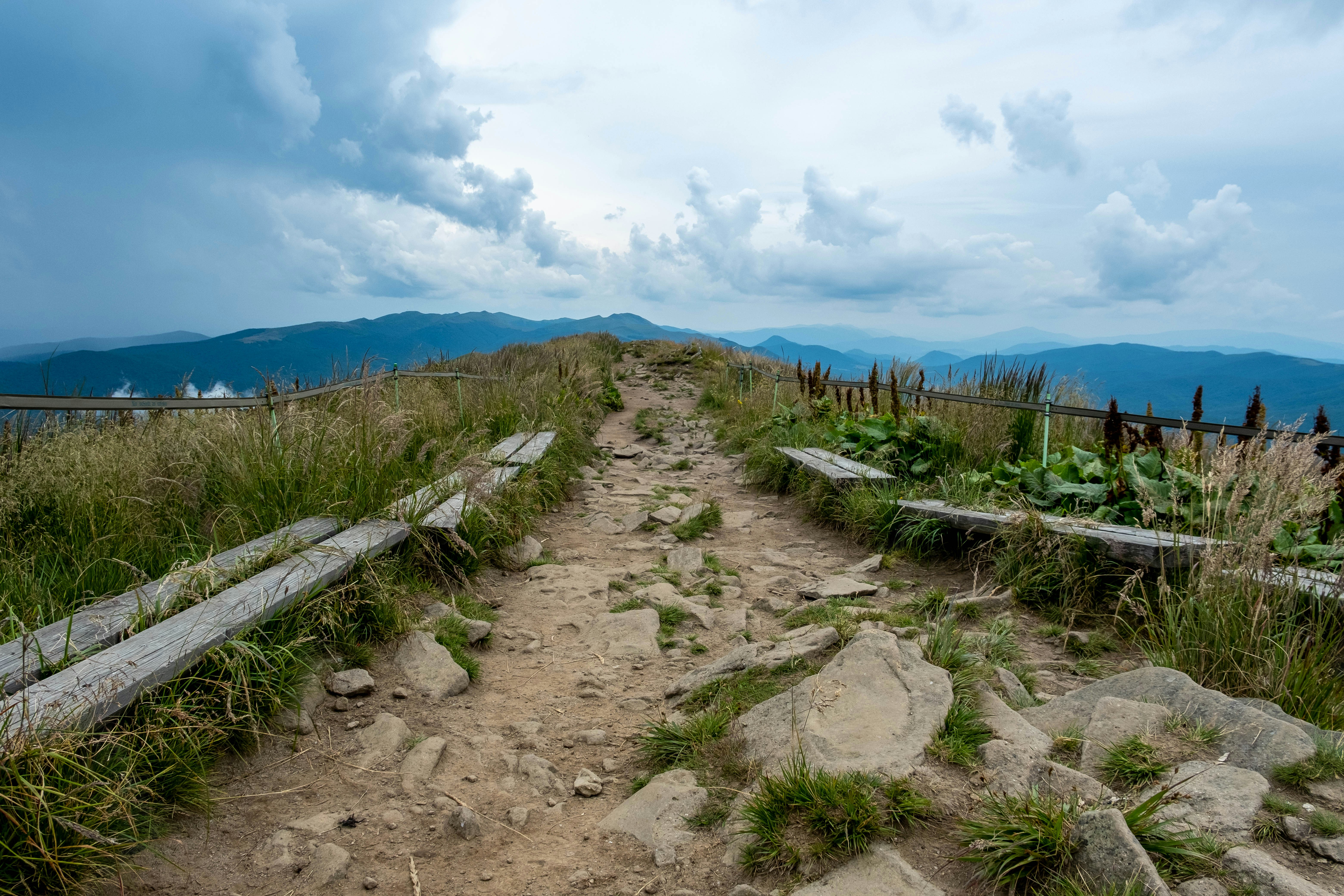 Trail to the Ridge: Weathered Benches and Rocky Path to the Horizon