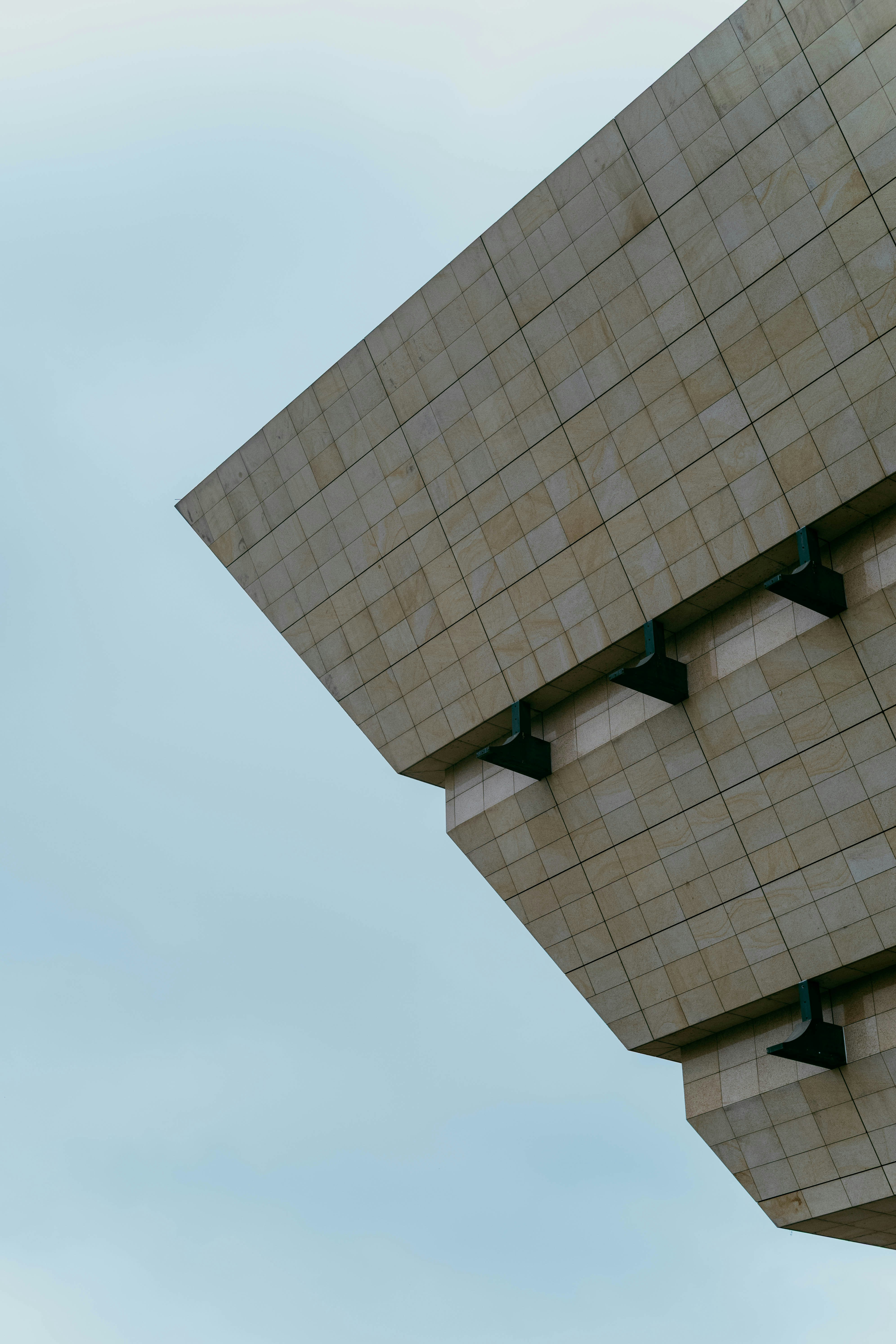 Diagonal Overhang: Concrete Geometry Against a Blue Sky