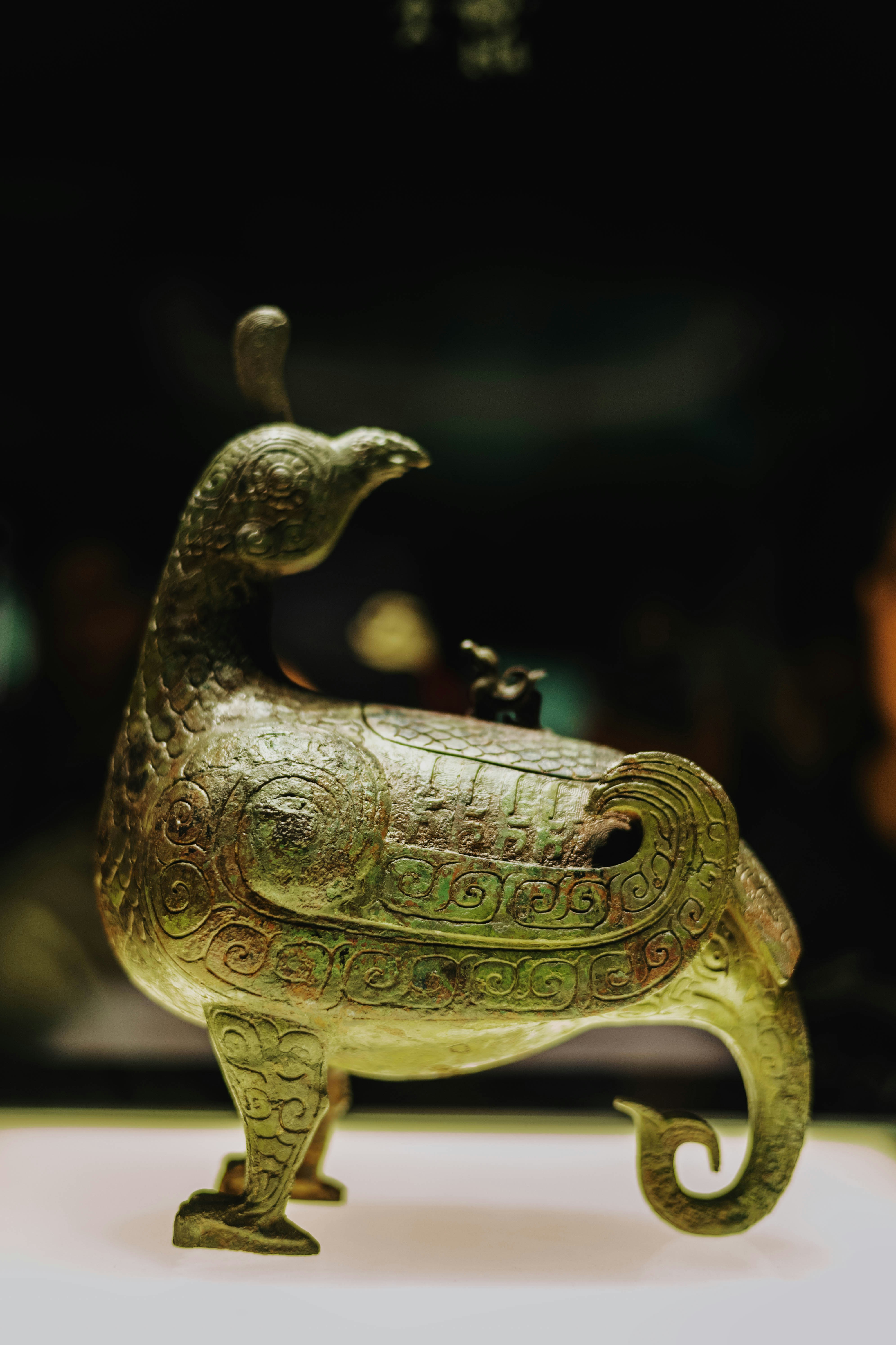 Ancient Stylized Steed: A Bronze Carving under Spotlight