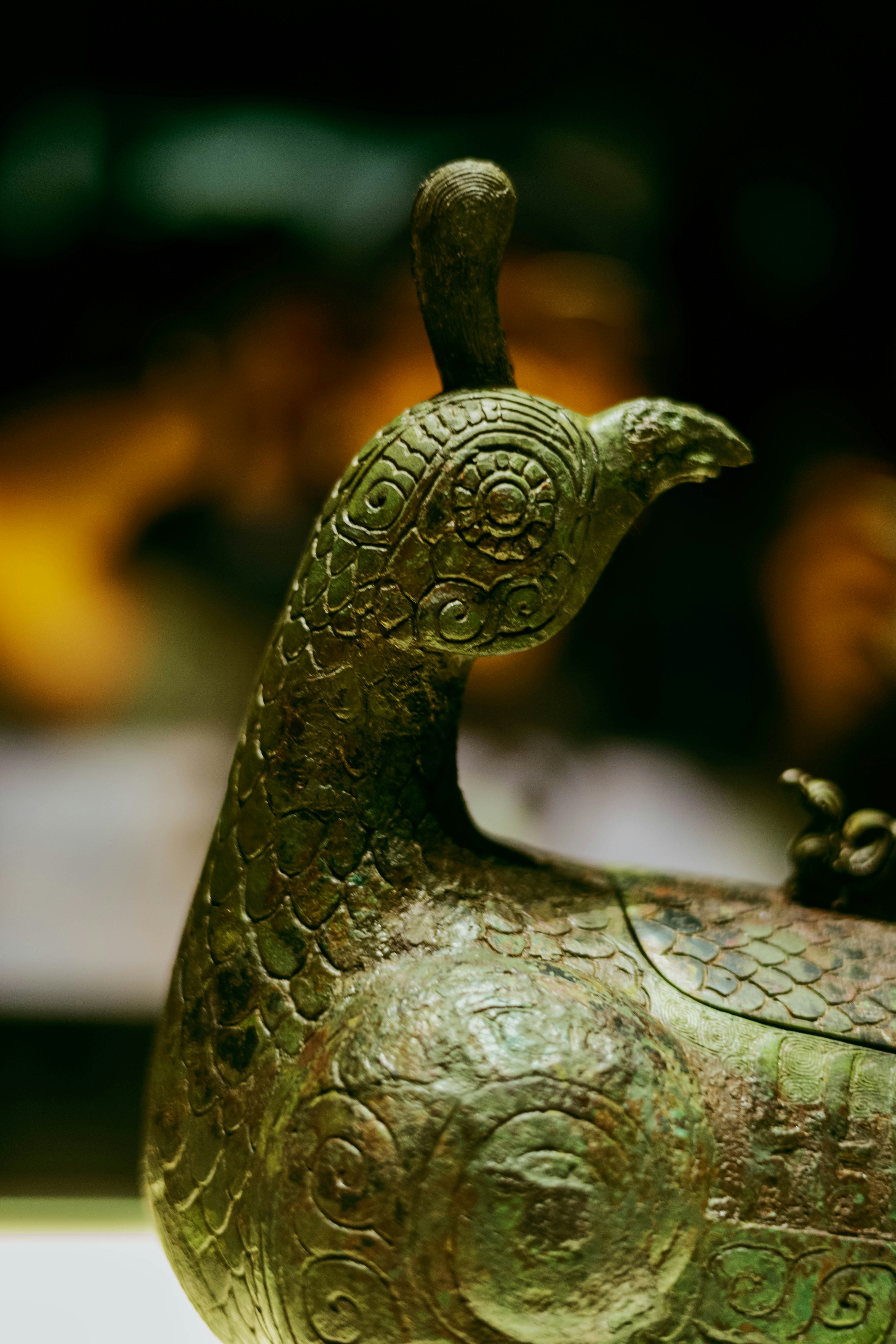 Curved Gaze: A Weathered Dragon-Chime Form Rising from Bronze