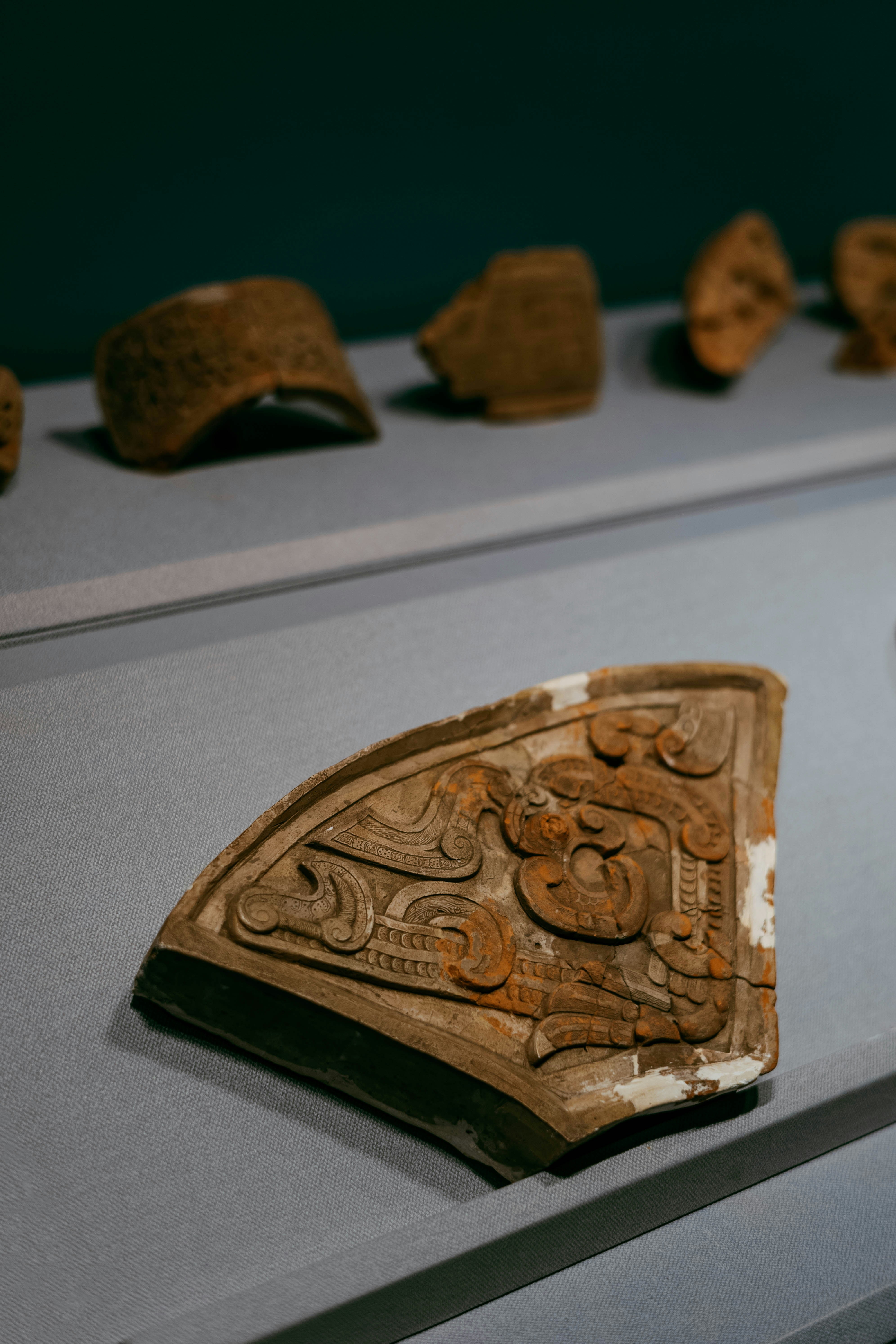 Fragment of Story: Ornate Roof Tile in a Museum Display