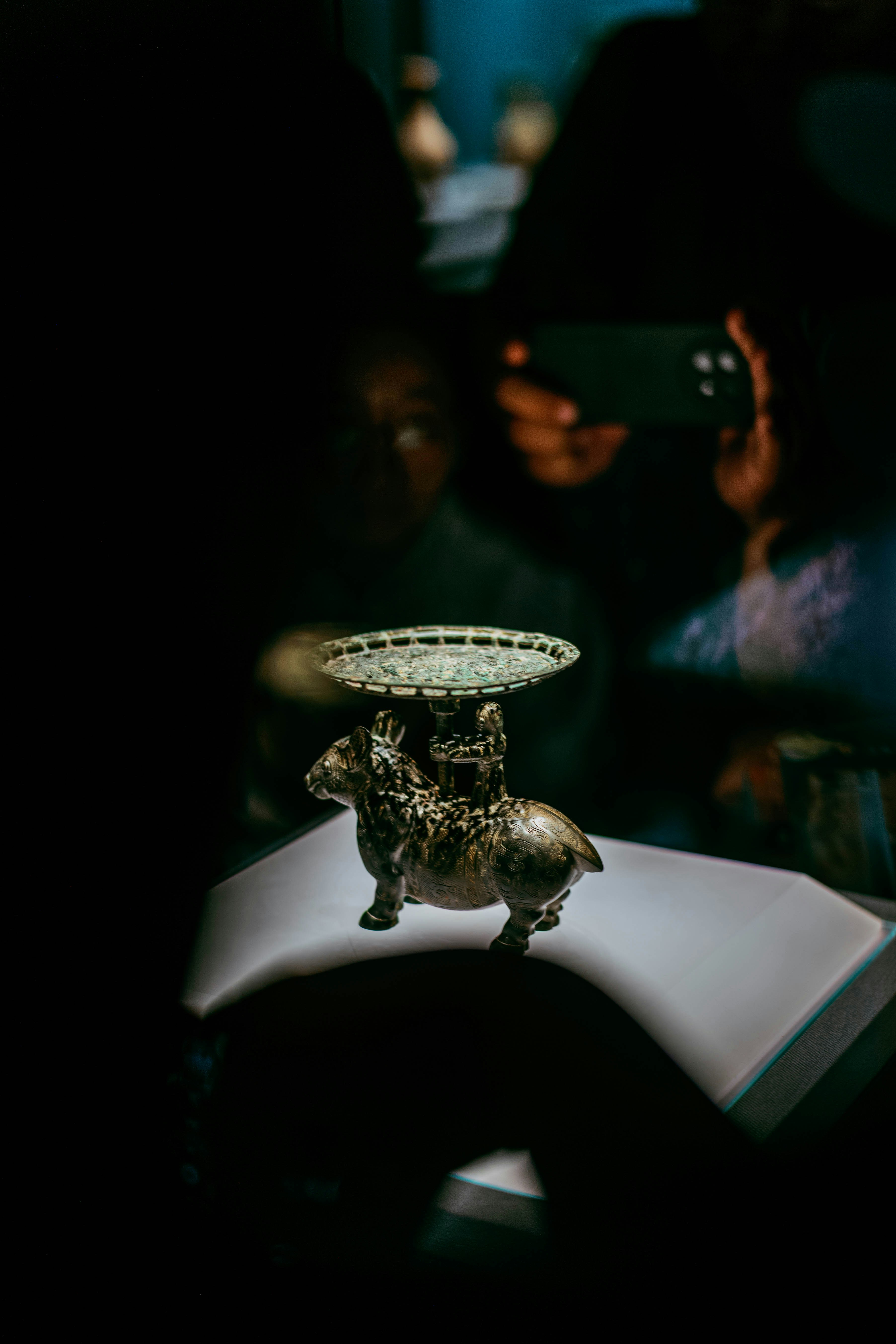 Ancient Horse-Shaped Vessel Under Soft Spotlight