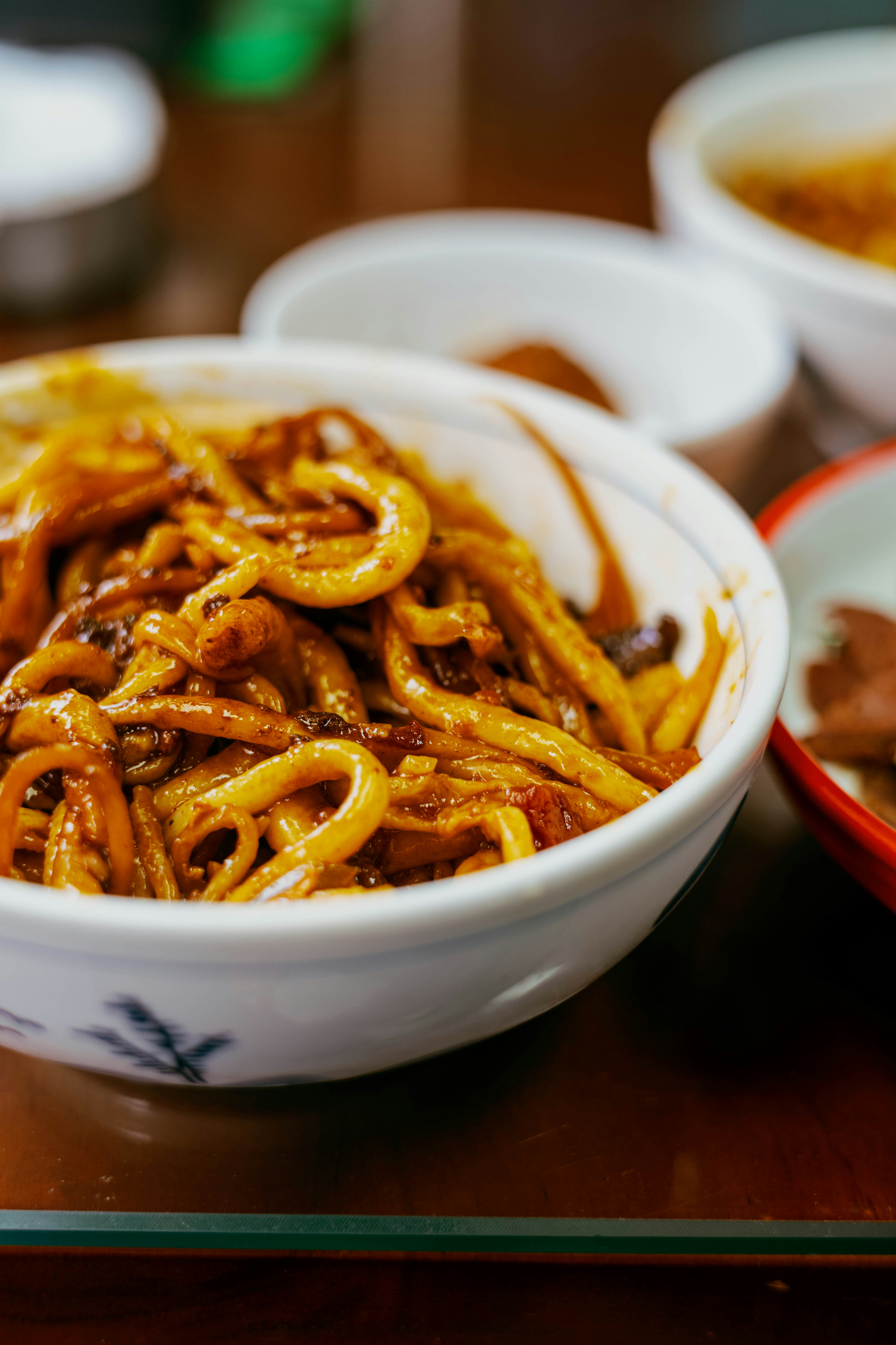 Steaming Noodles in a Ceramic Bowl, Center Stage on a Cozy Table
