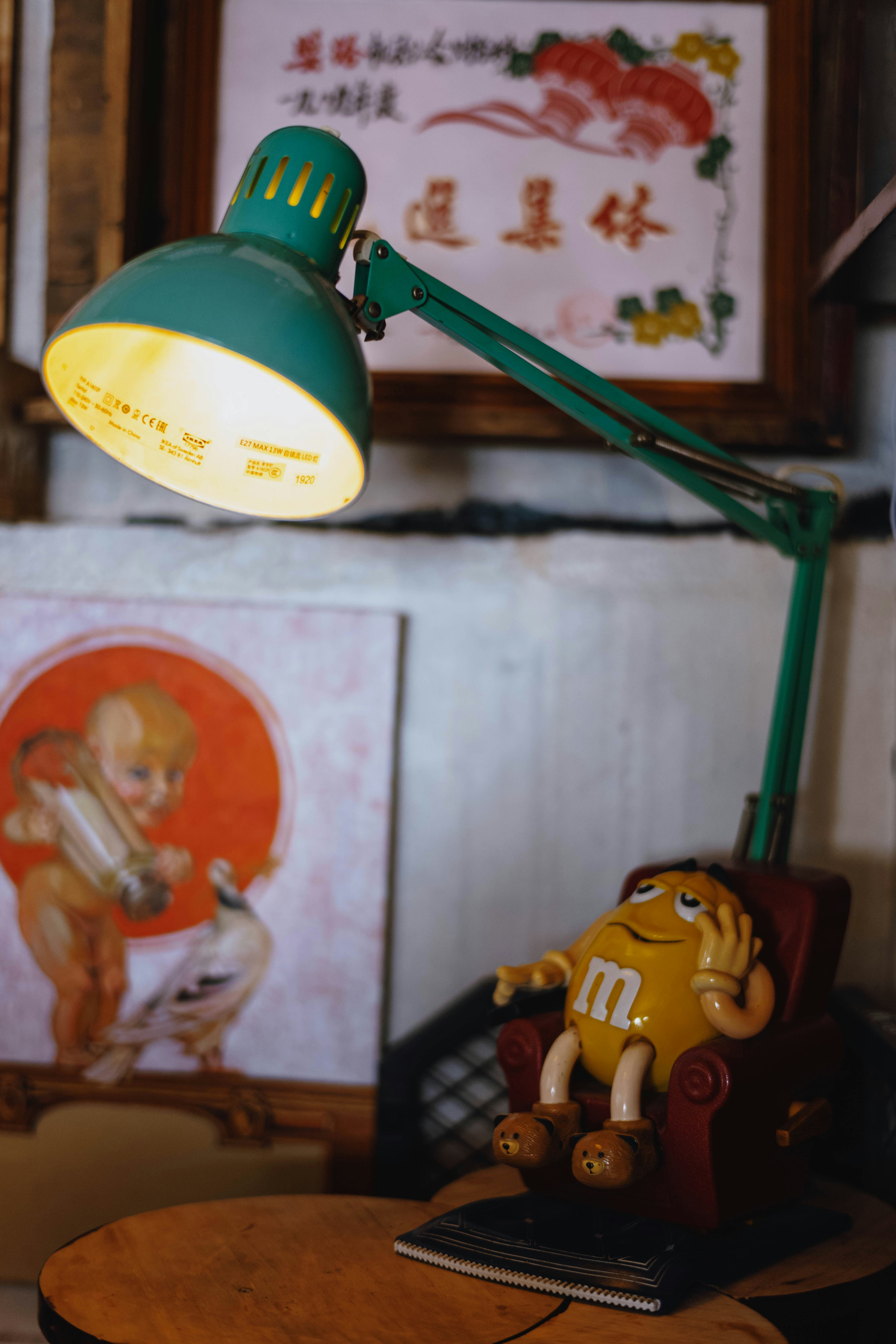 The Green Lamp and Golden M&M on a Quiet Desk
