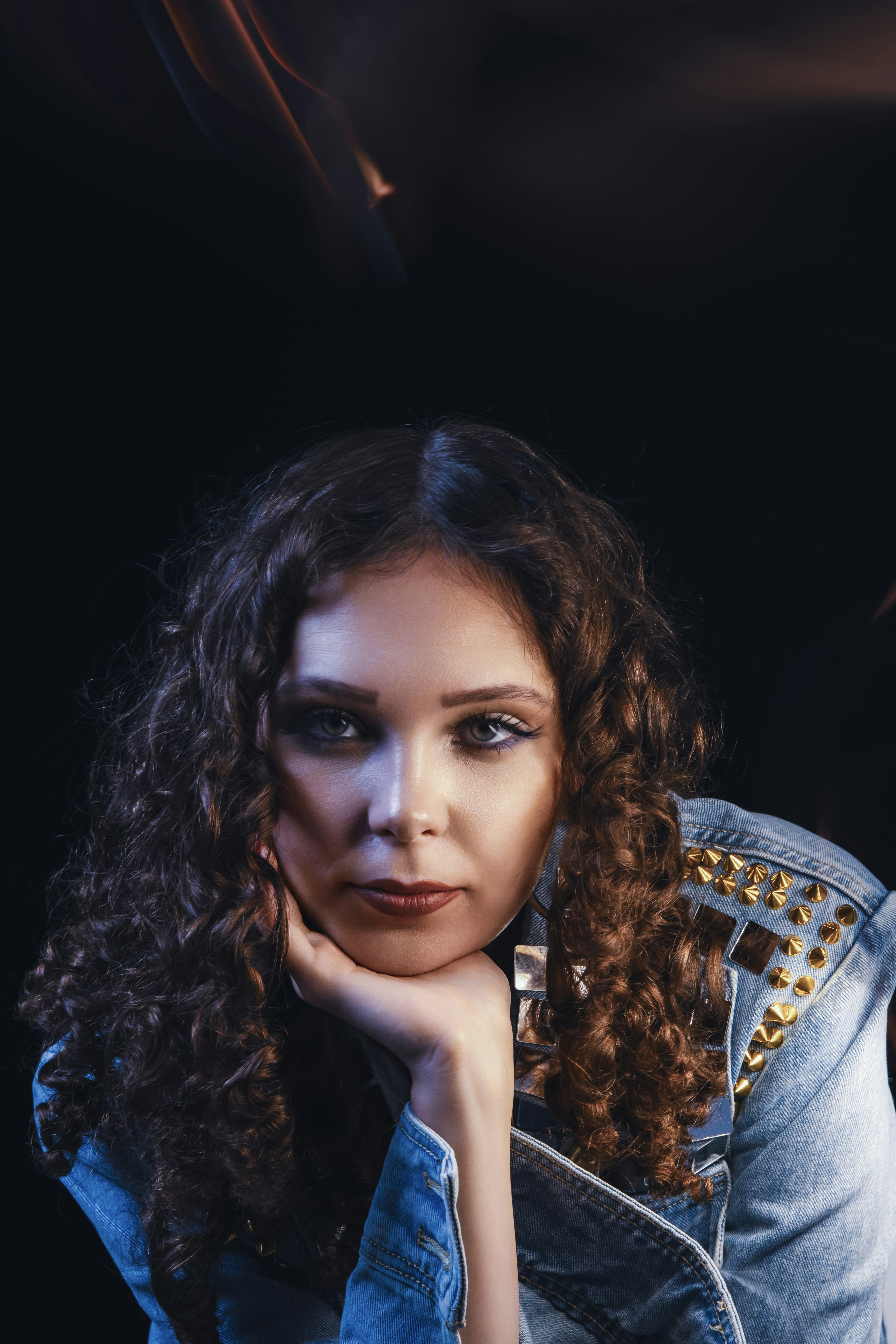 Curled Portrait Under Velvet Lights