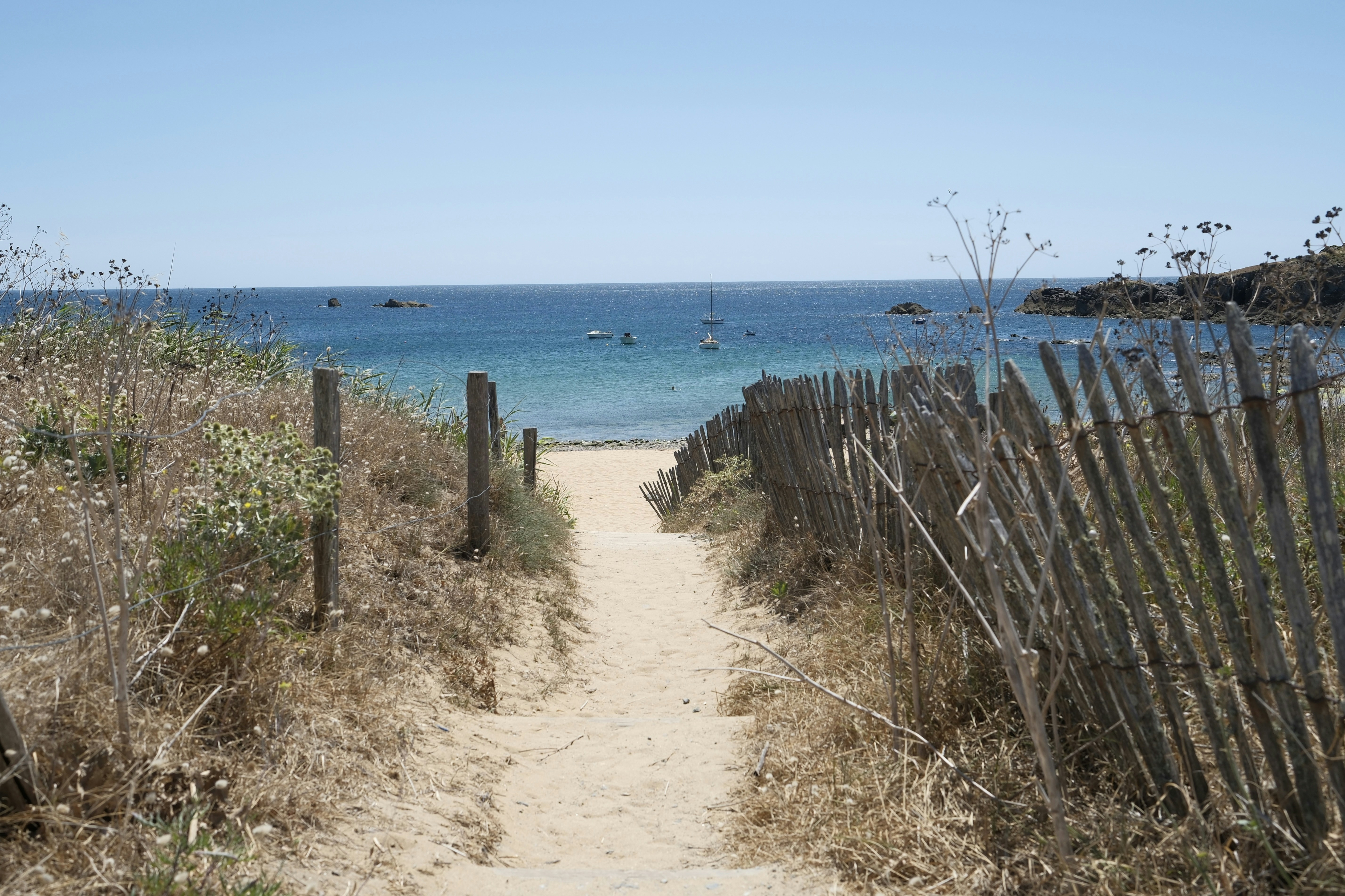 Path to the Sea: A dune-lined corridor opening to blue horizons