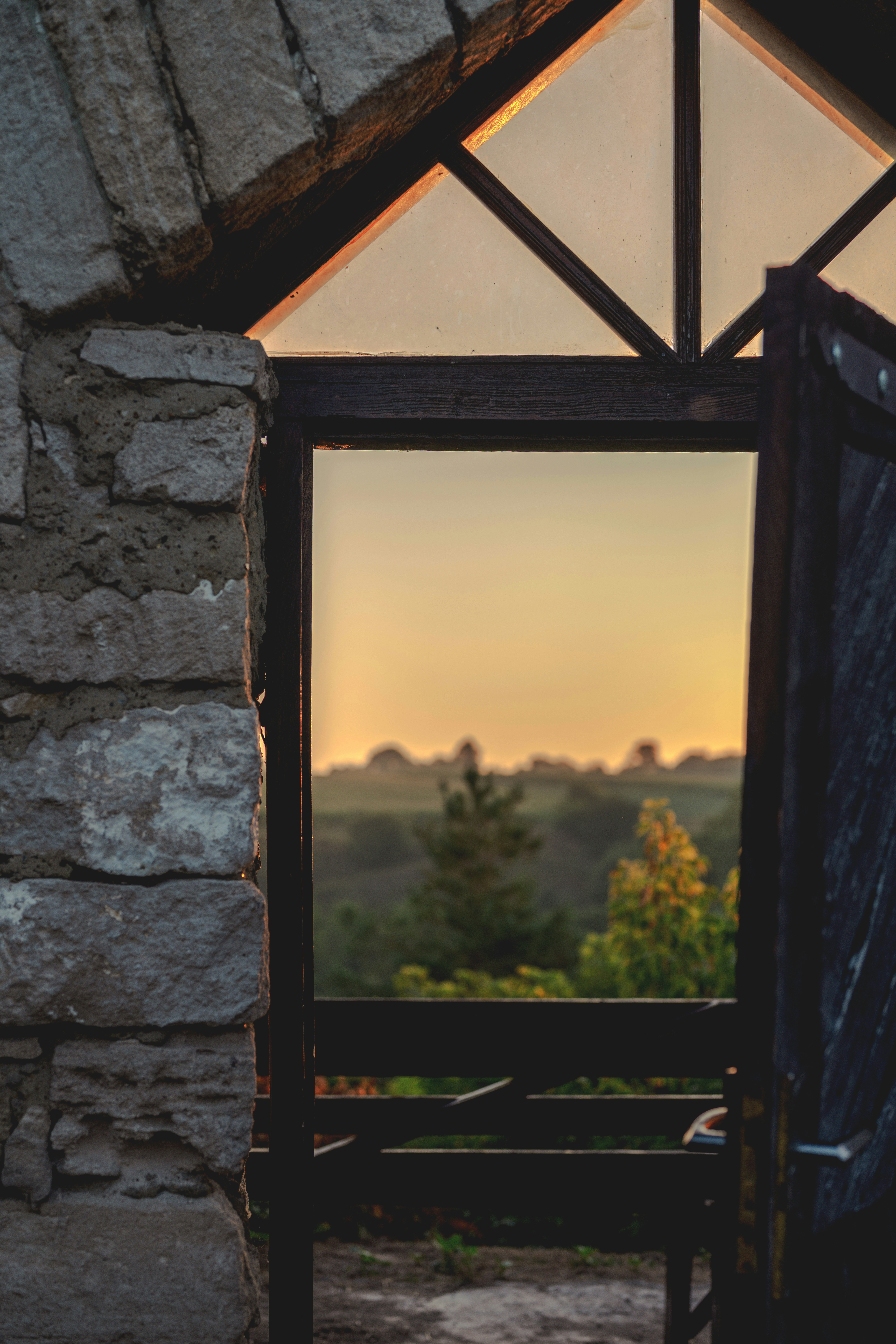 Frame to the Horizon: A Sunlit Doorway to Quiet Fields