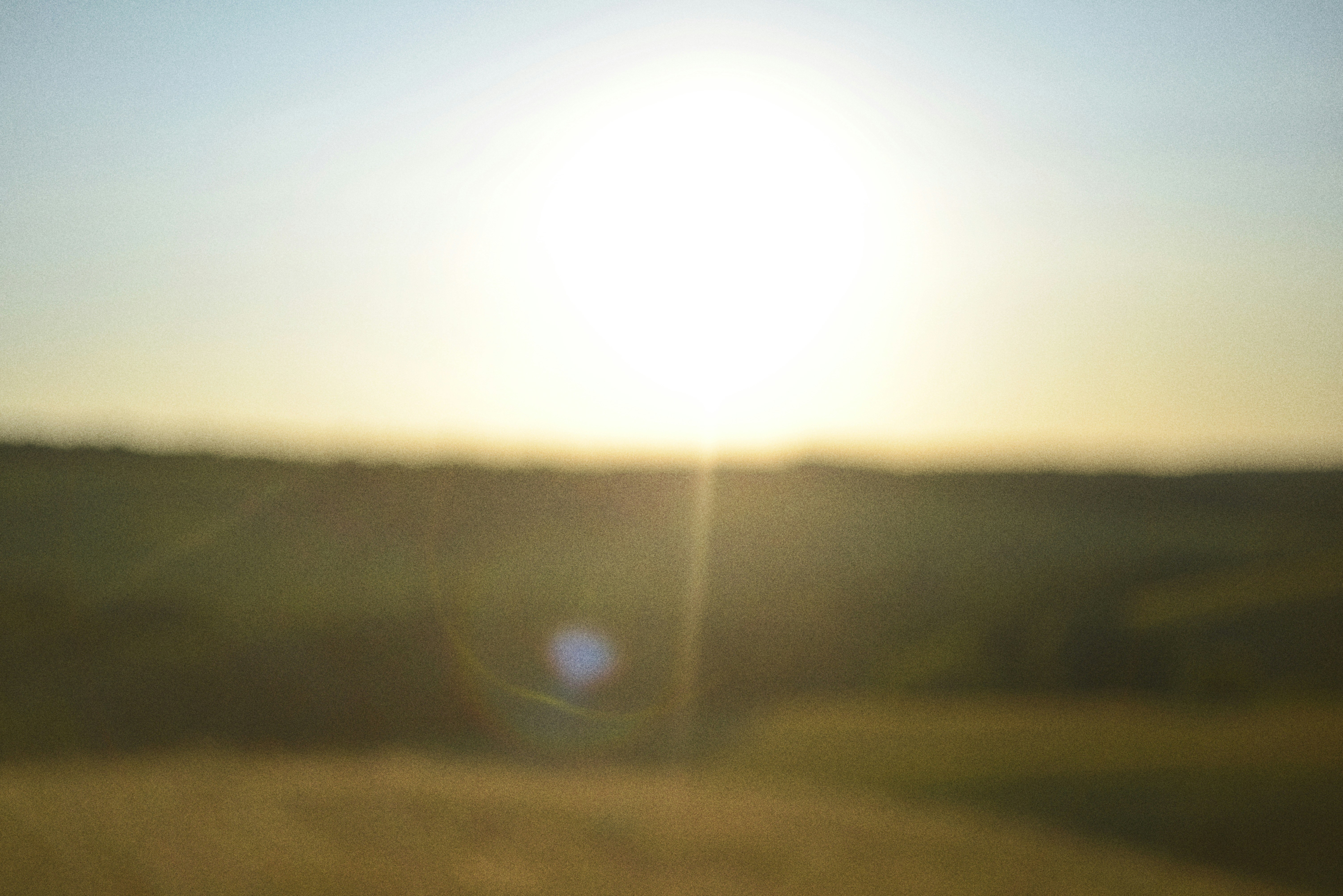 Blurry Horizon at Dusk: Sunlit Horizon with Soft Lens Glow
