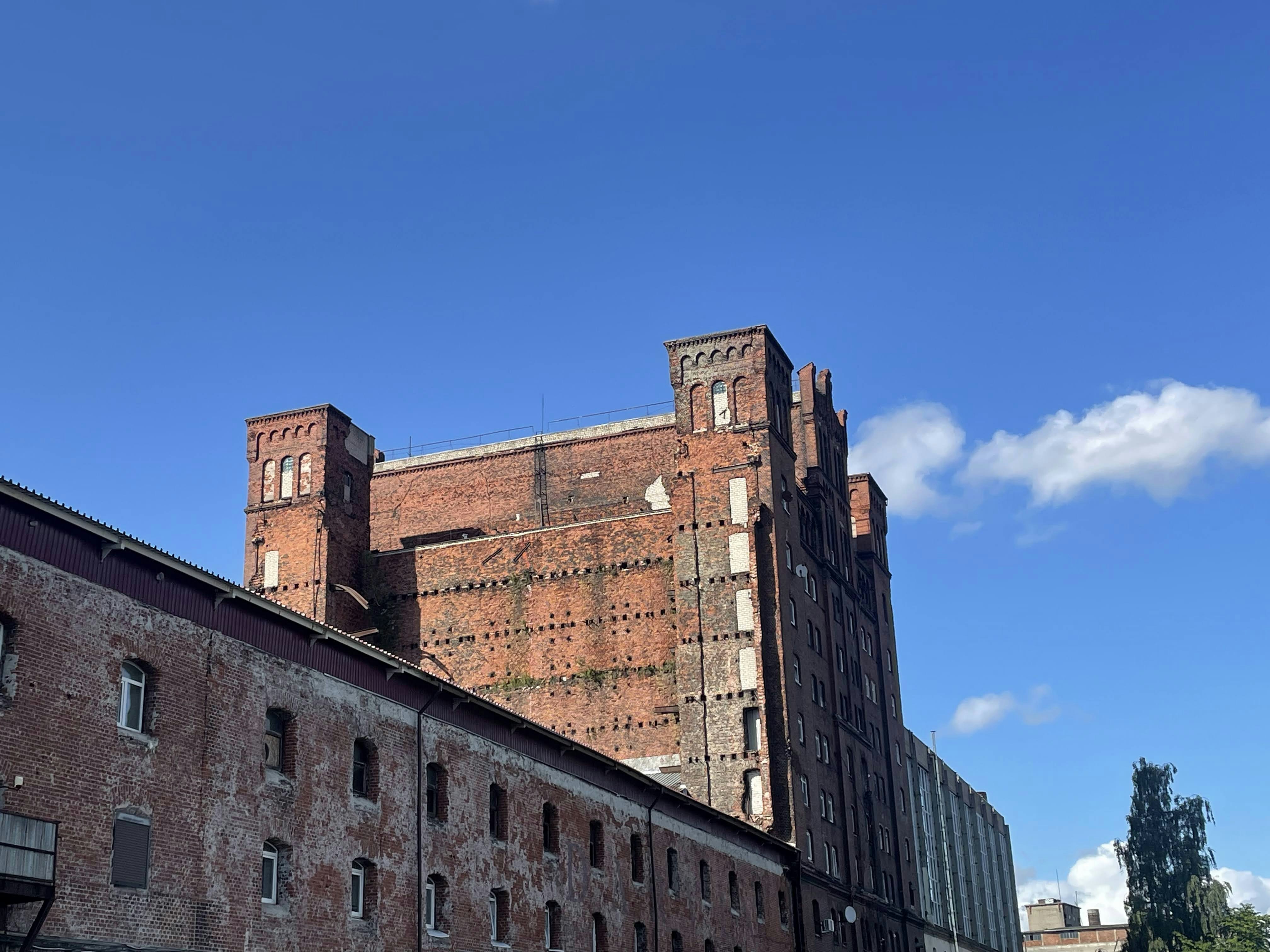 Brick Tower Monolith Under a Bright Blue Sky