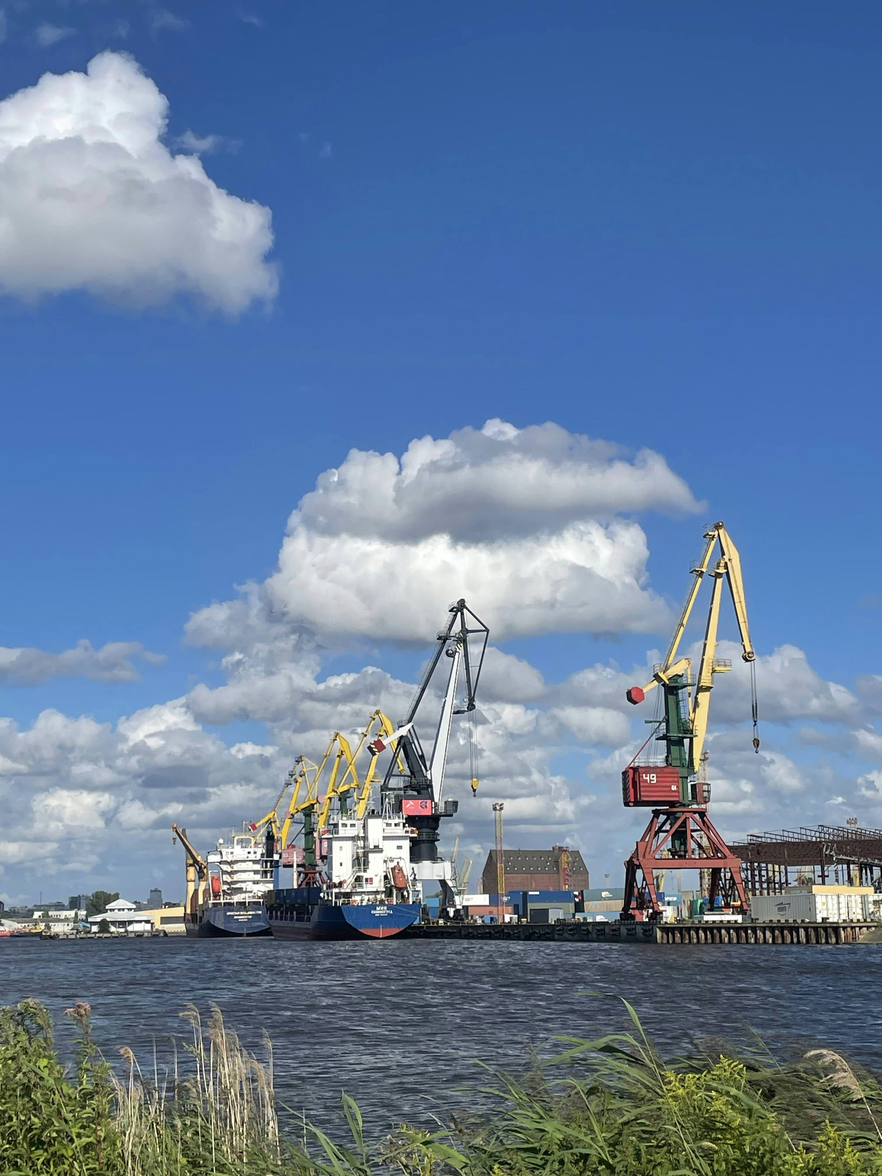 Harbor Giants: Cranes and Ships at Dusk