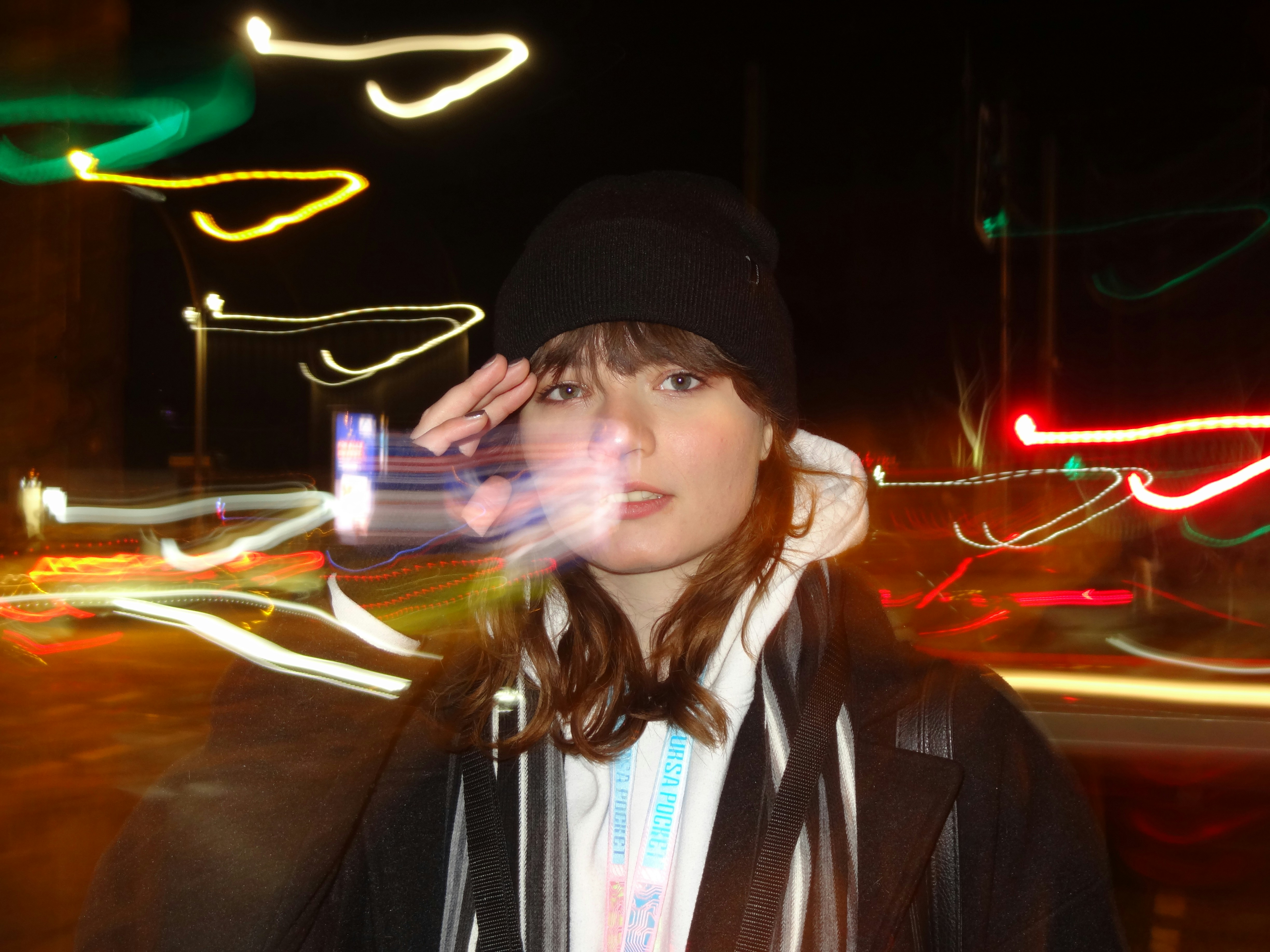 Night Street Portrait: A Beanie-Clad Moment in Motion