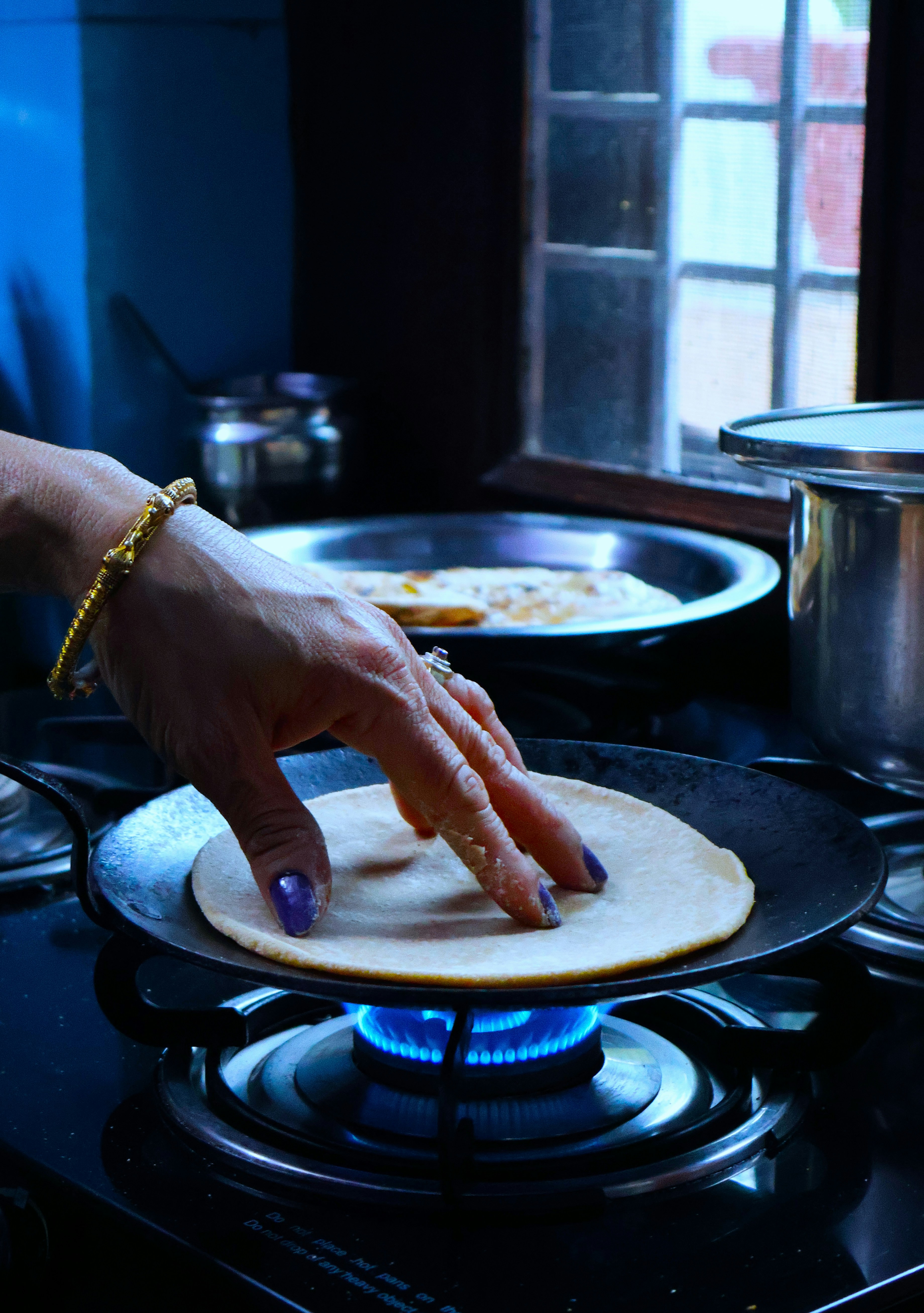 Hand Pressed Crepe Beneath a Blue Flame