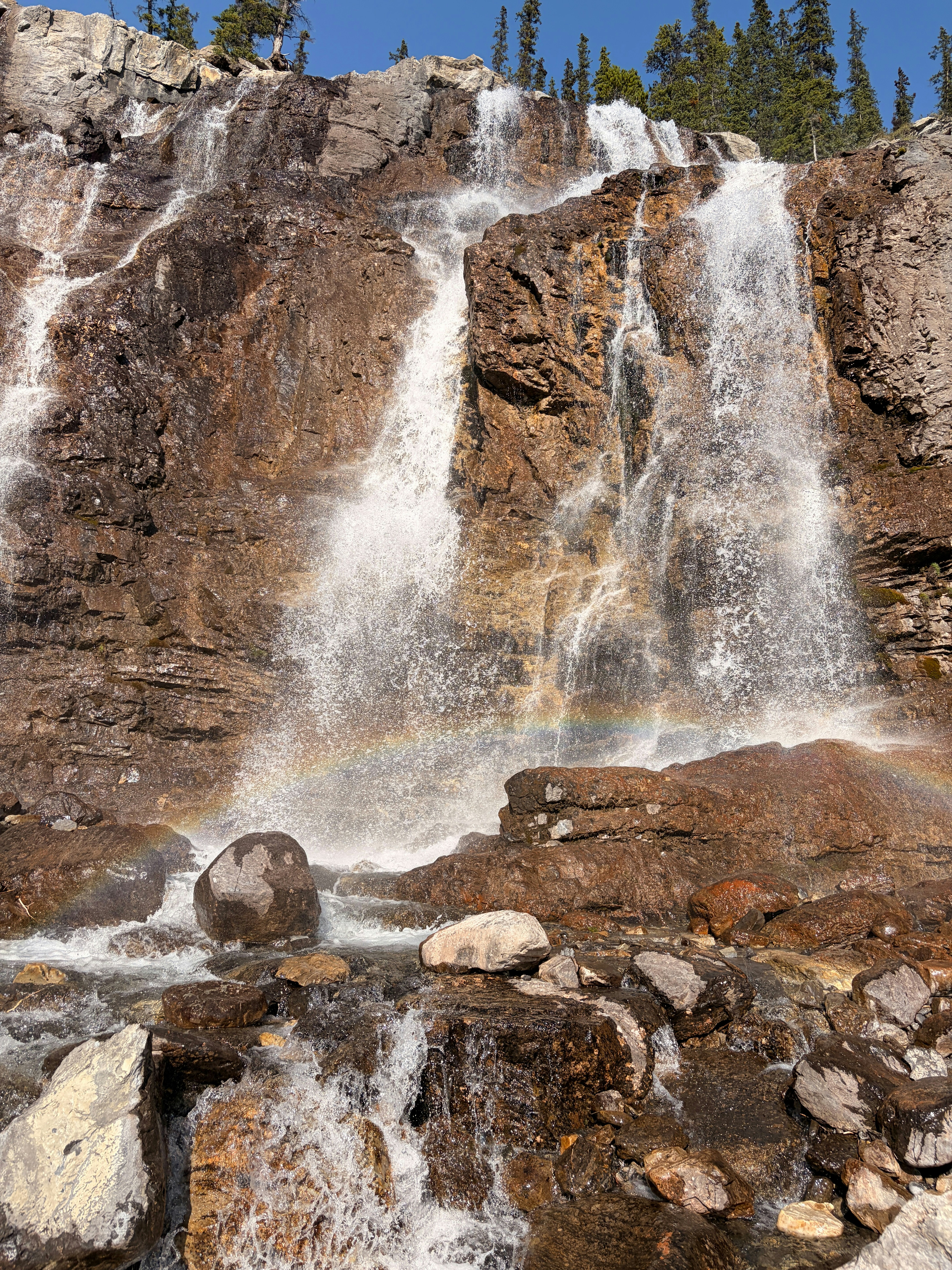 Cascade Across Tumbling Rocks: A Sunlit Fallscape