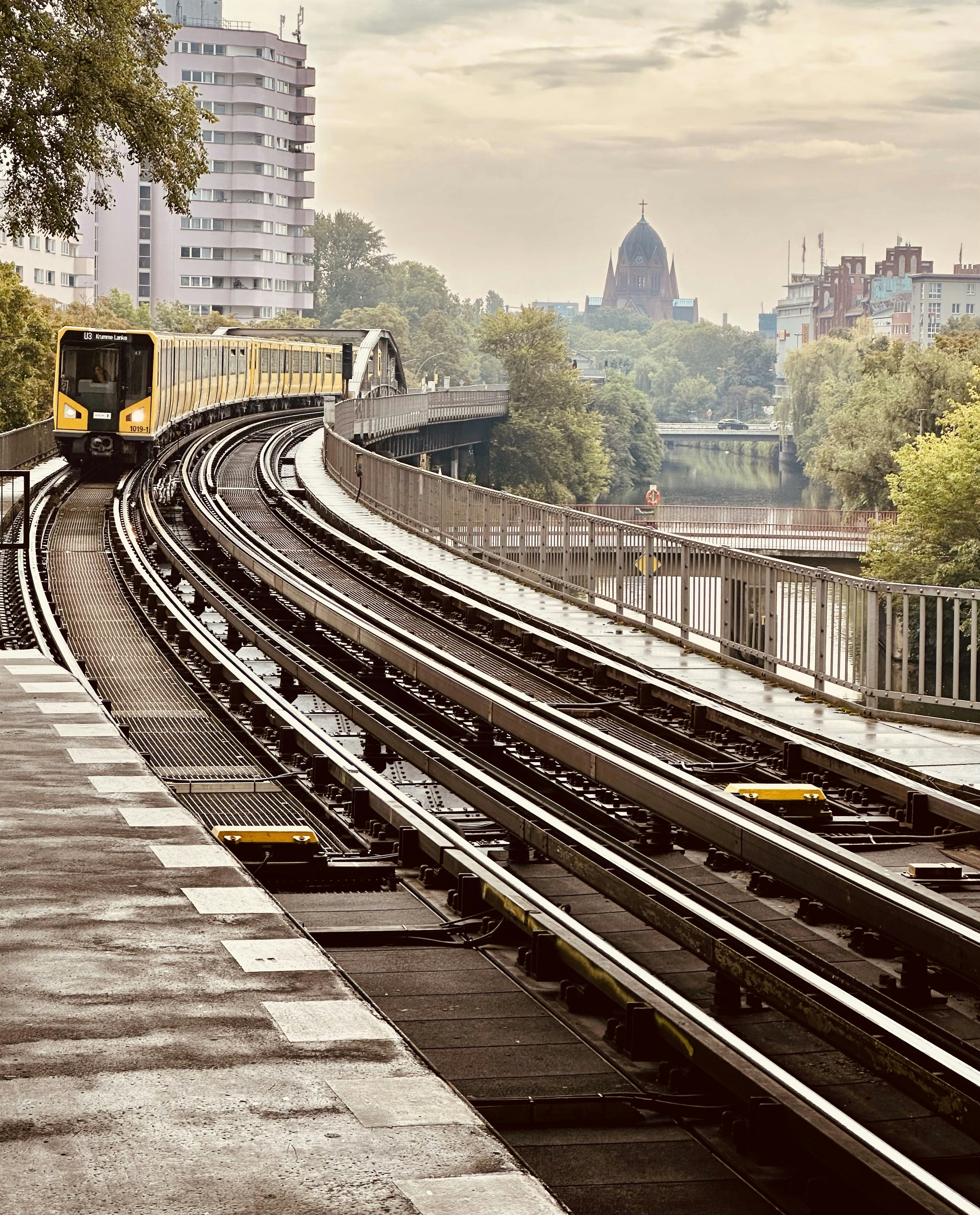 Curved Rails Toward the Cityscape