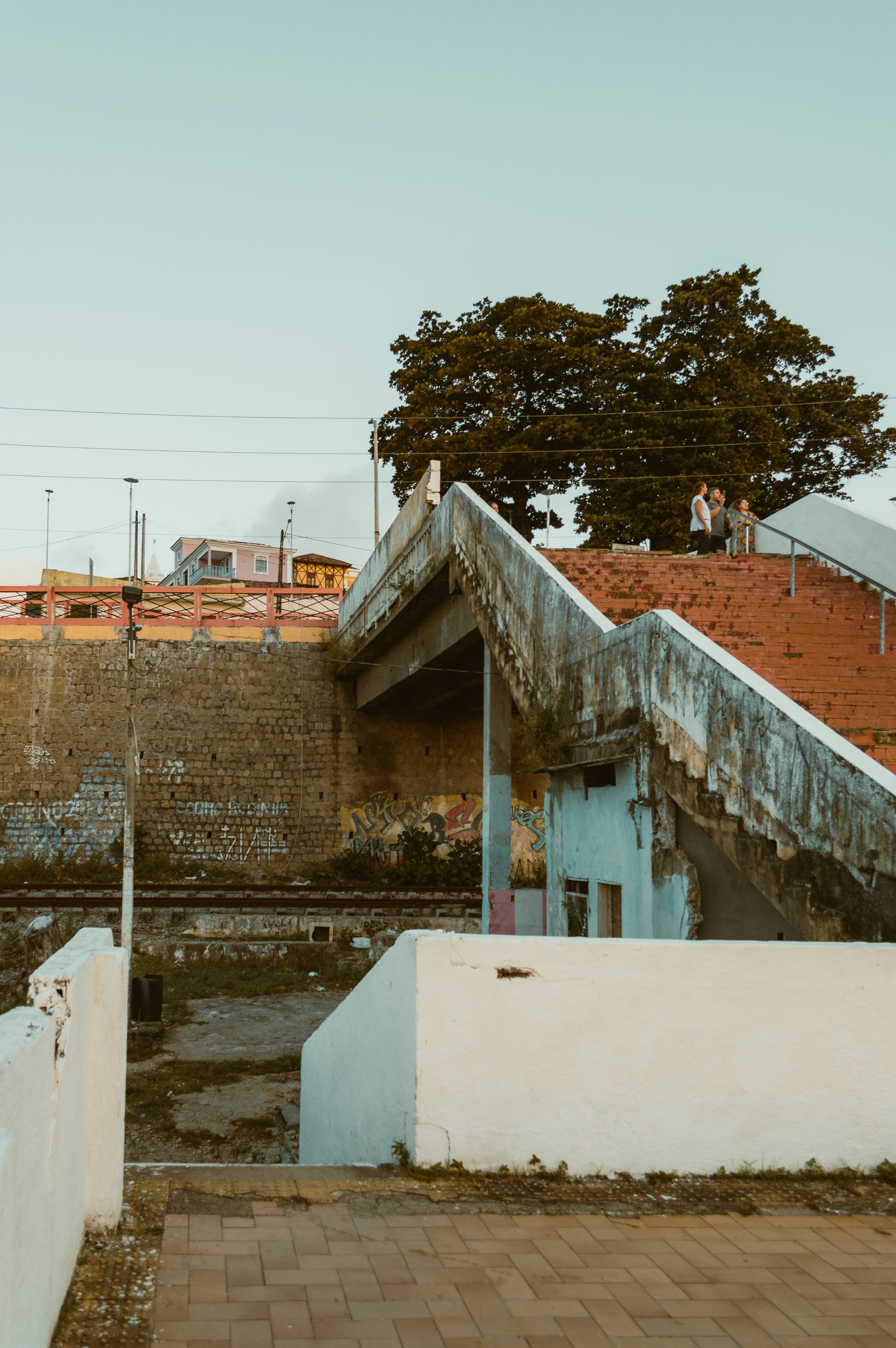 Sunlit Staircase Overlook at Distant Rooftops
