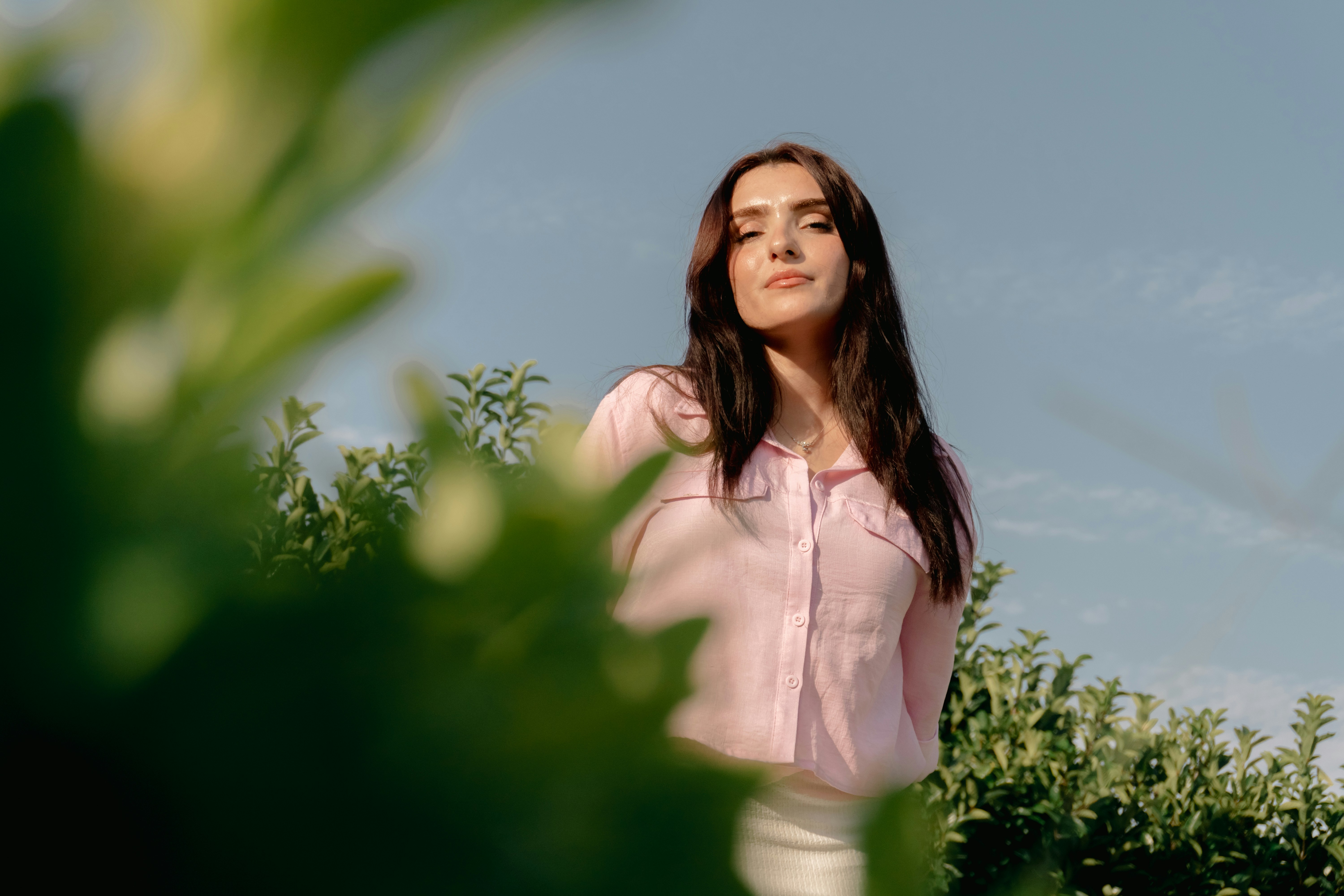 Sunlit Confidence: A Portrait among Greenery