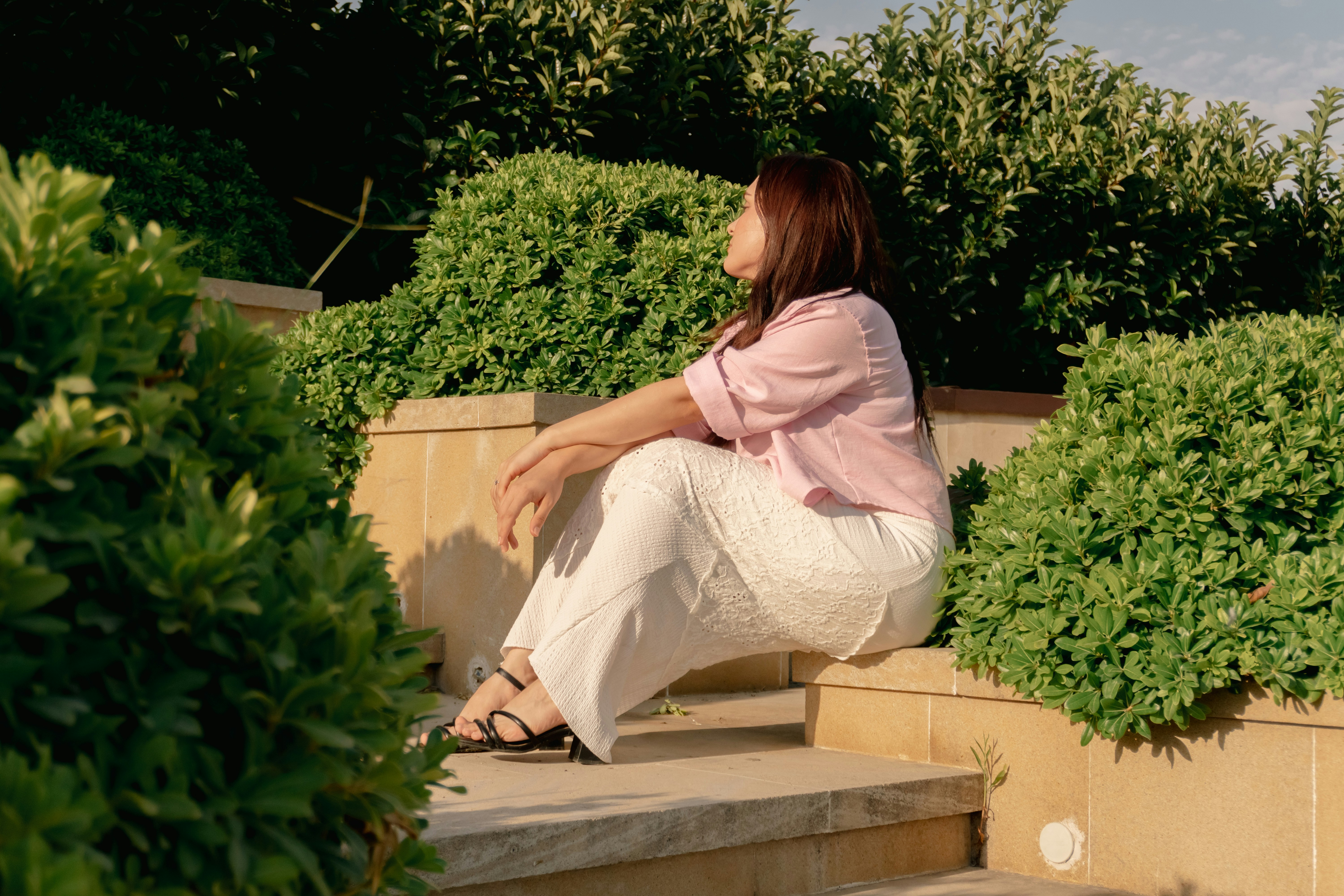 Sunlit Serenity: A Woman in Soft Pink by Verdant Steps