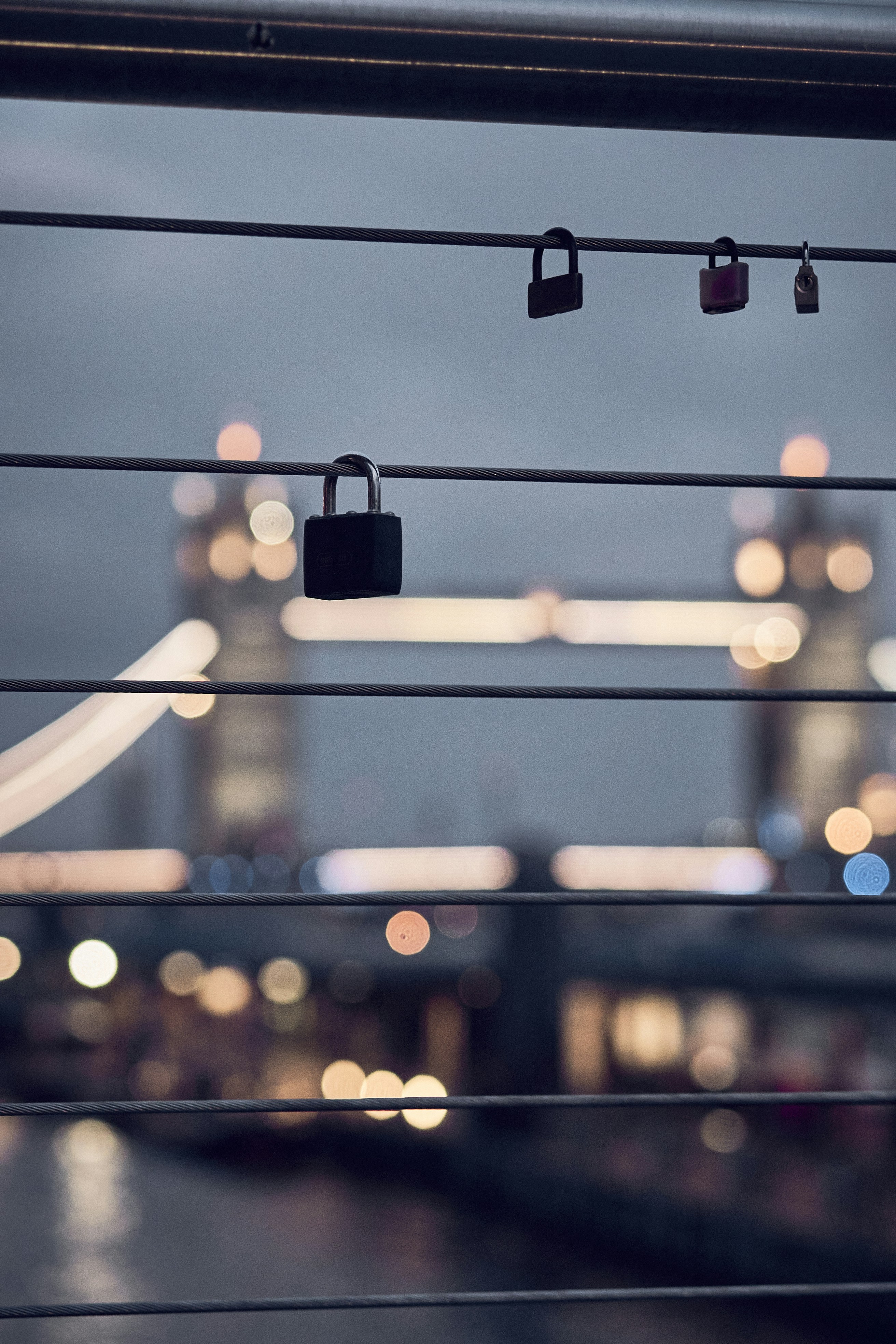 Locked in Quiet City Lights: Pads on a Rail Against a Blurred Skyline