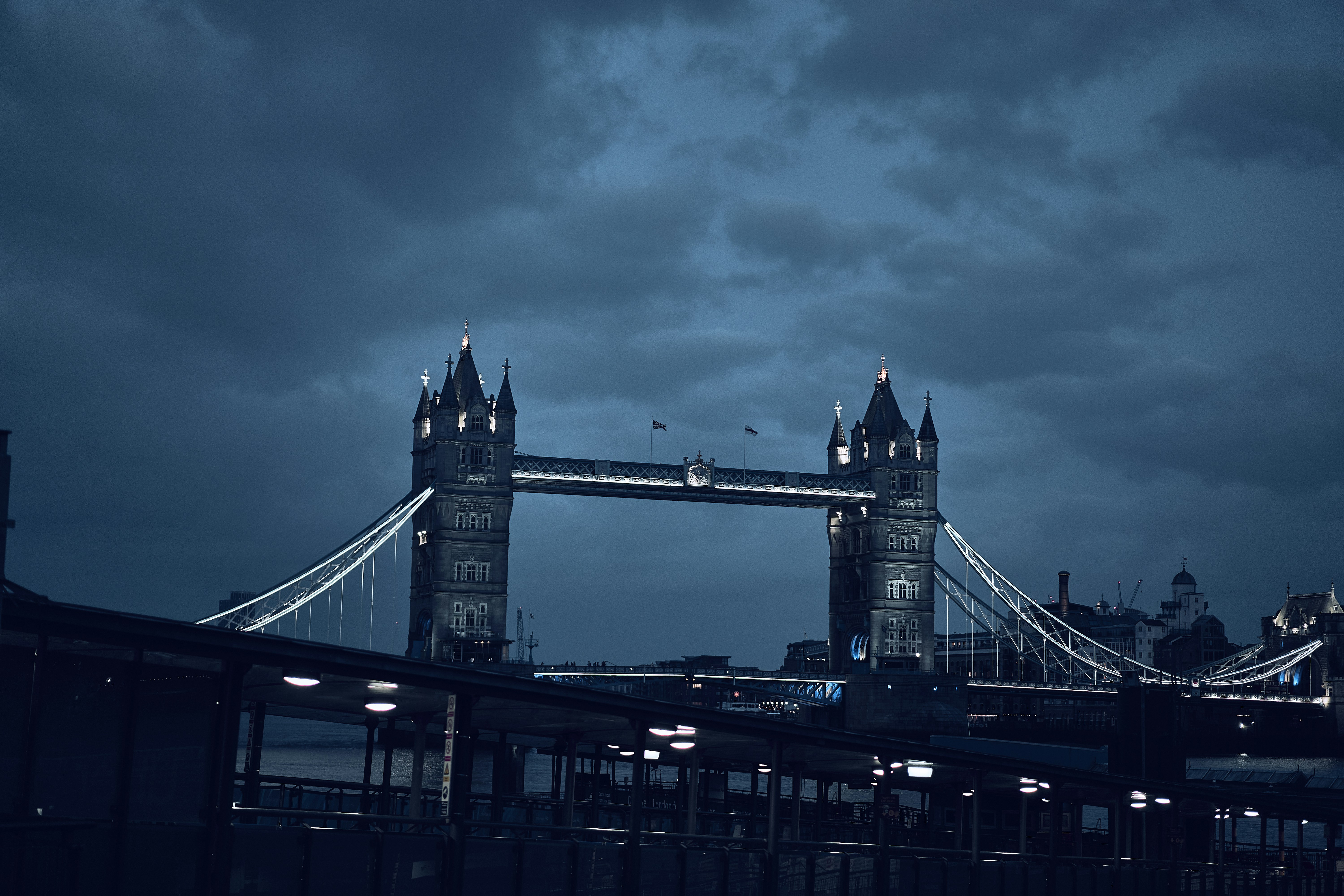 Midnight Bridge: Towering Towers Under a Clouded Sky