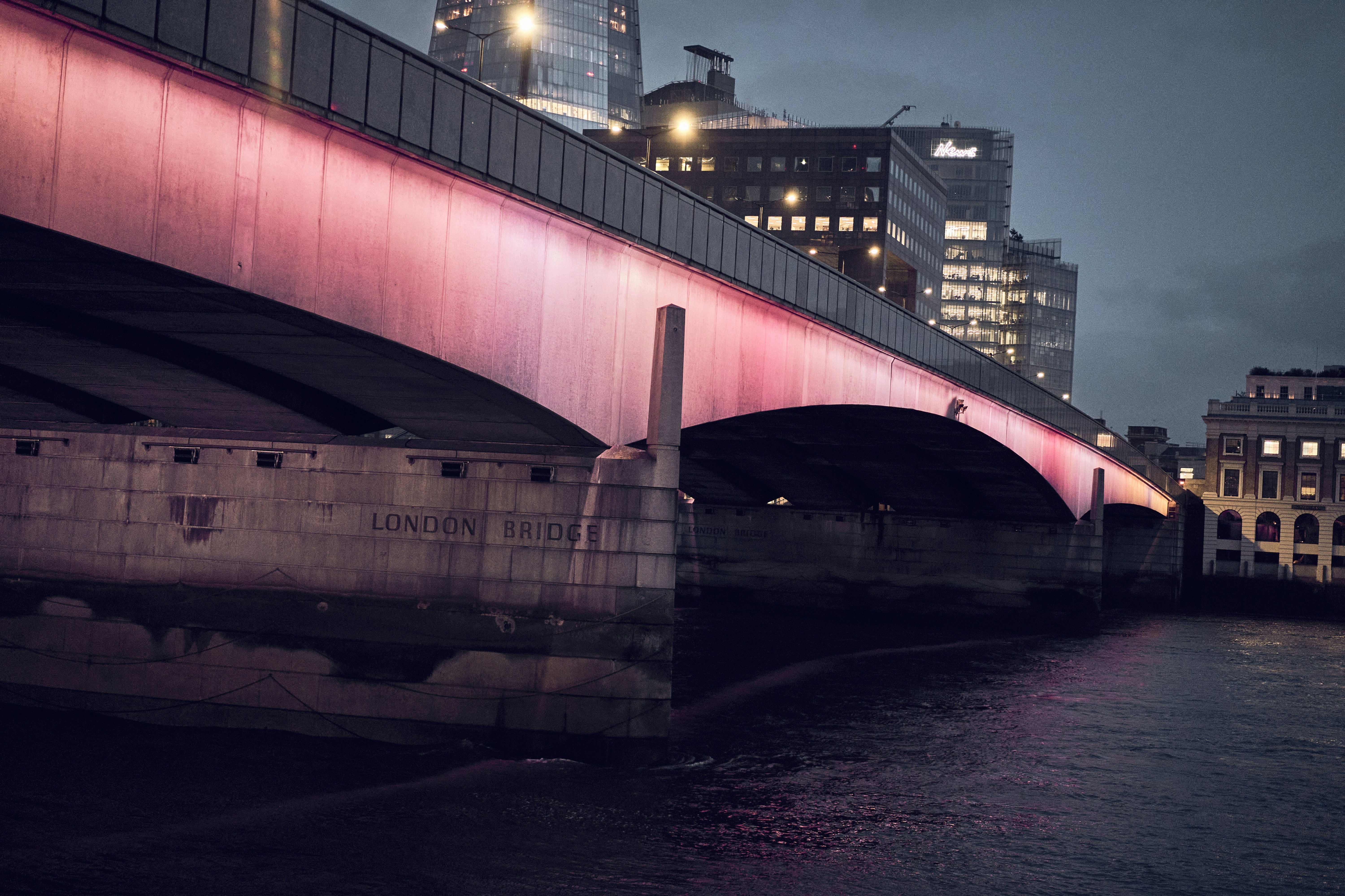 Neon-lit River Crossing over the London Bridge at Dusk