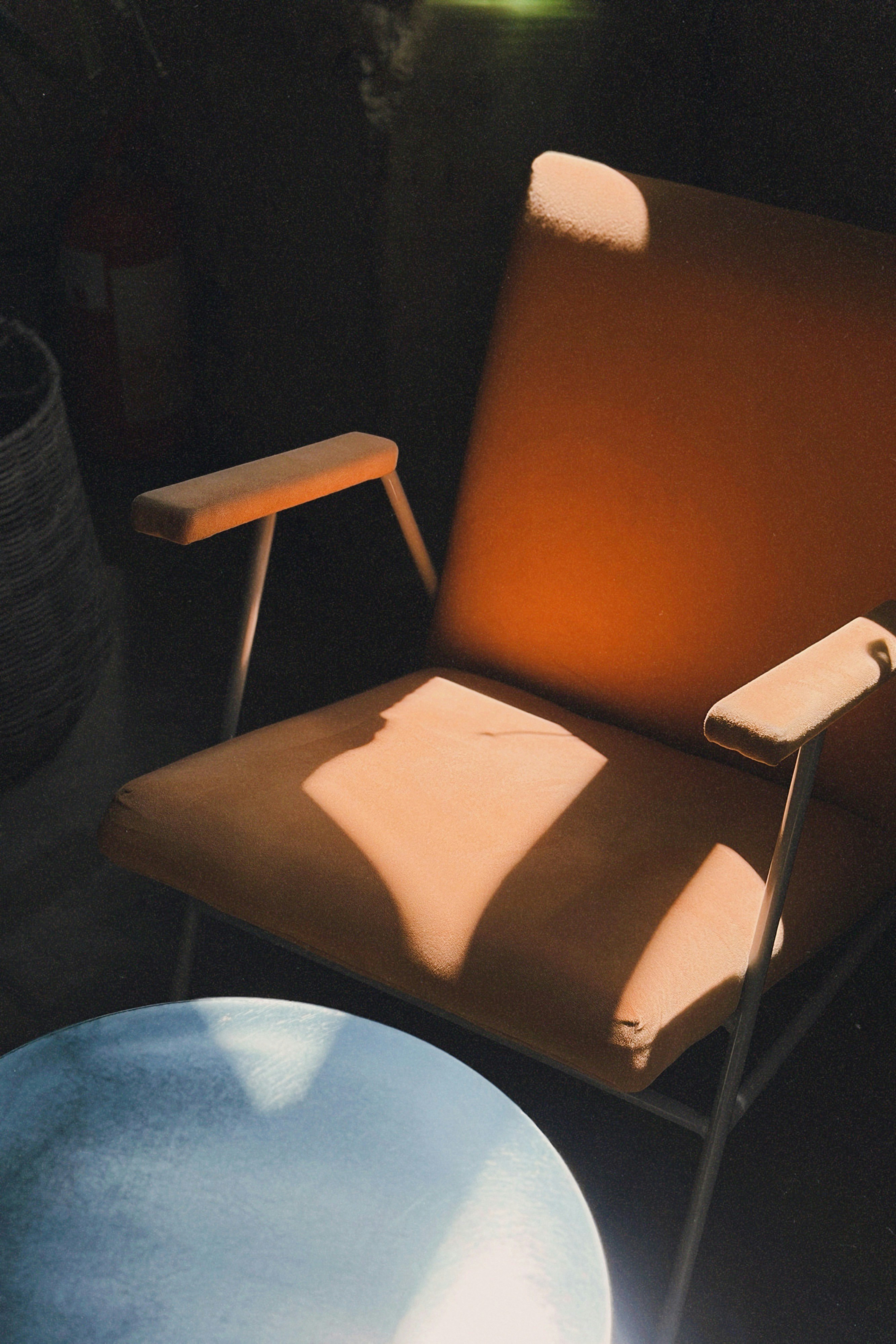 Sunlit Leather Armchair in Dim Studio