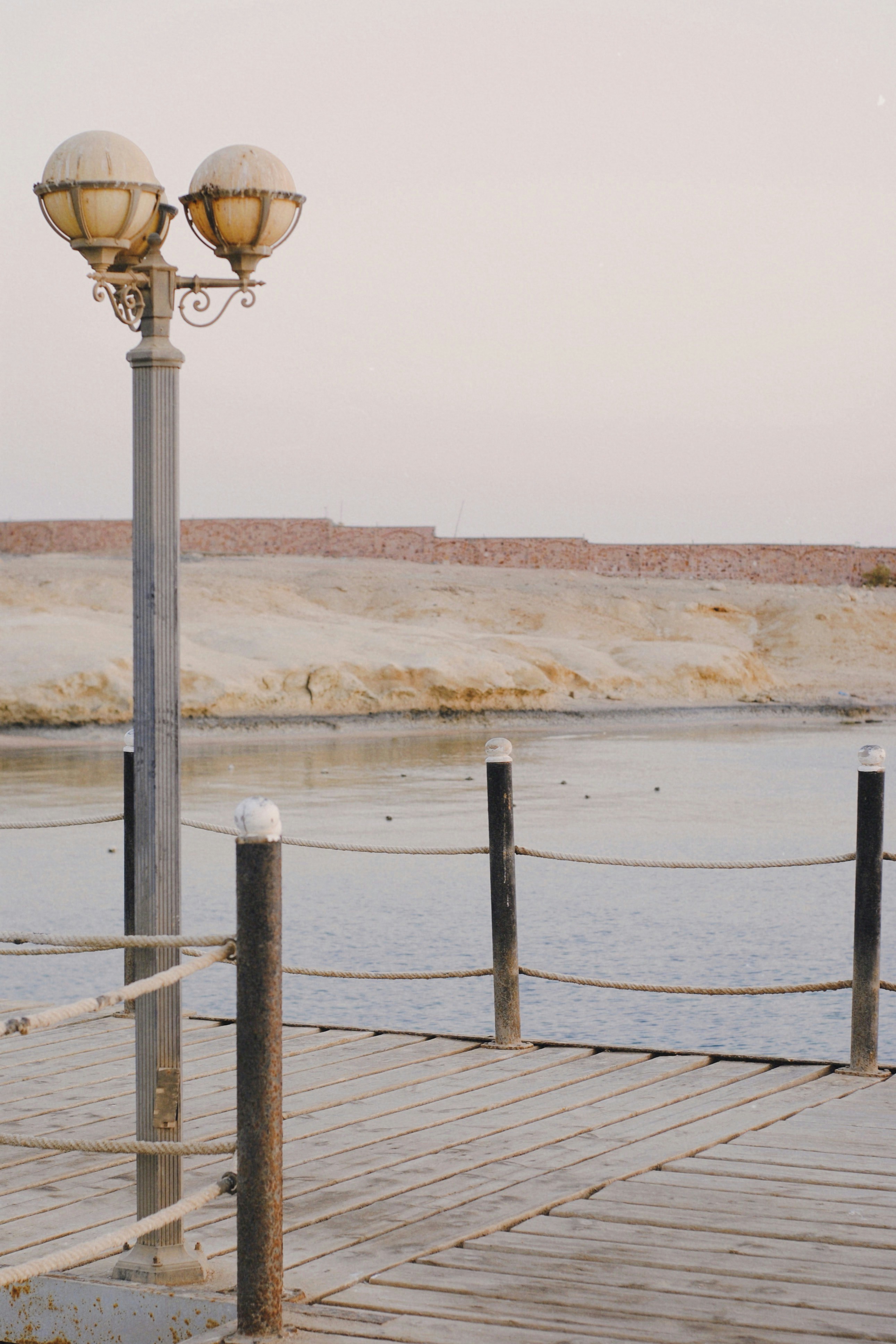 Pastel Pier at Dusk: A Quiet Waterfront with Vintage Lanterns