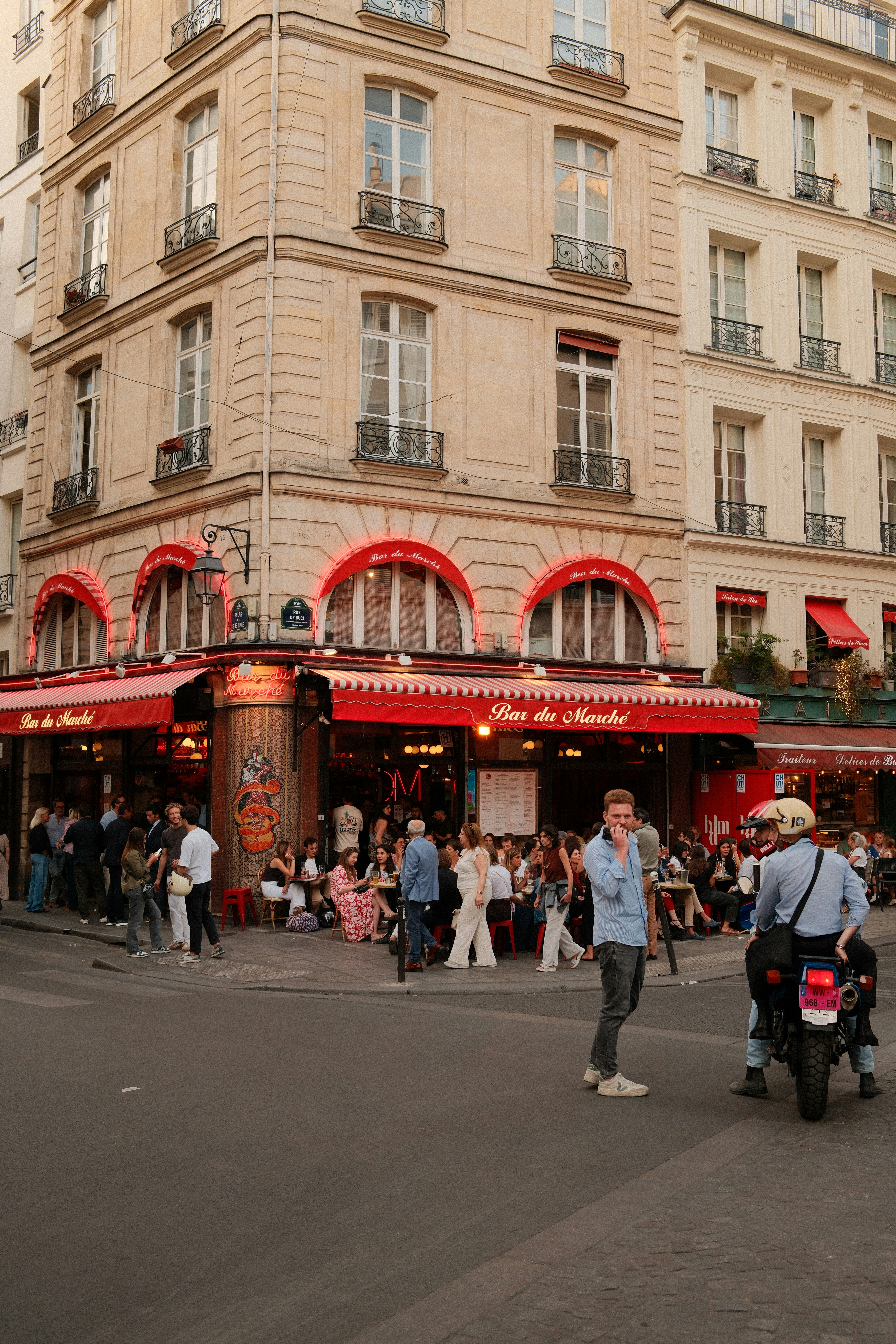 Red Canopy of Paris: A Café Scene Under The Arcaded Facade