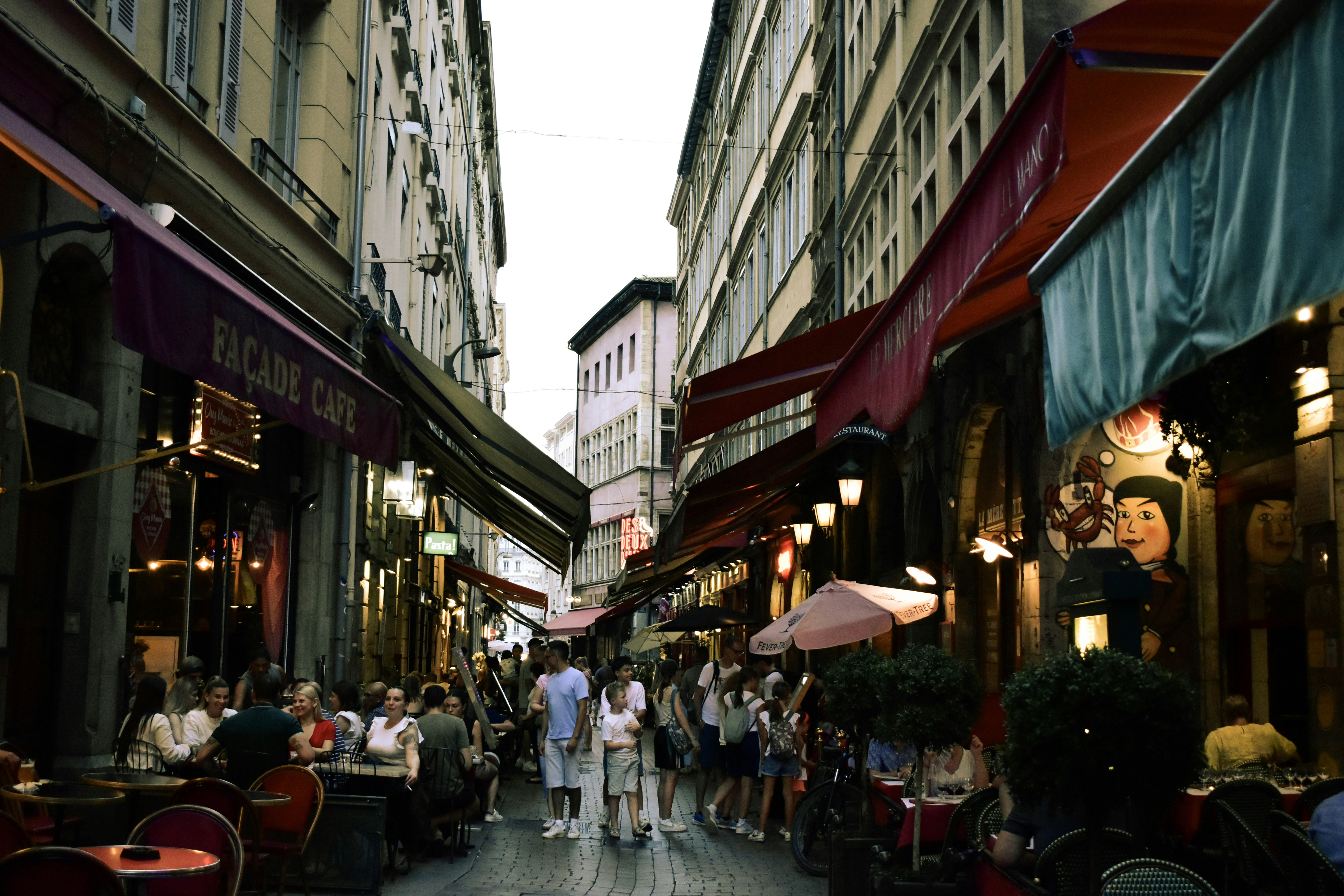 Cobbled Street Café Confluence: People, Light, and Lanterns