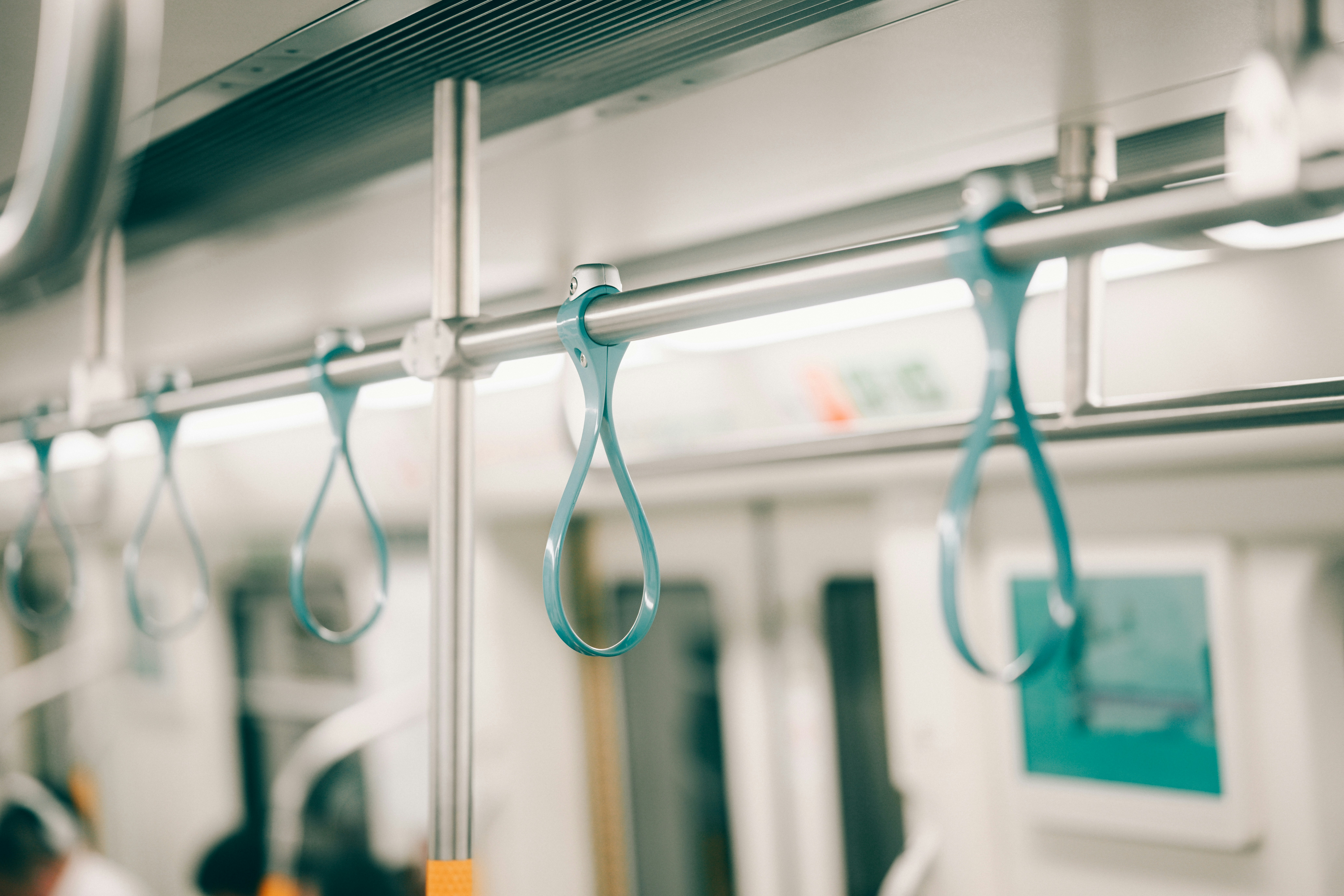 Suspended Handles and Soft Focus in a Quiet Commute